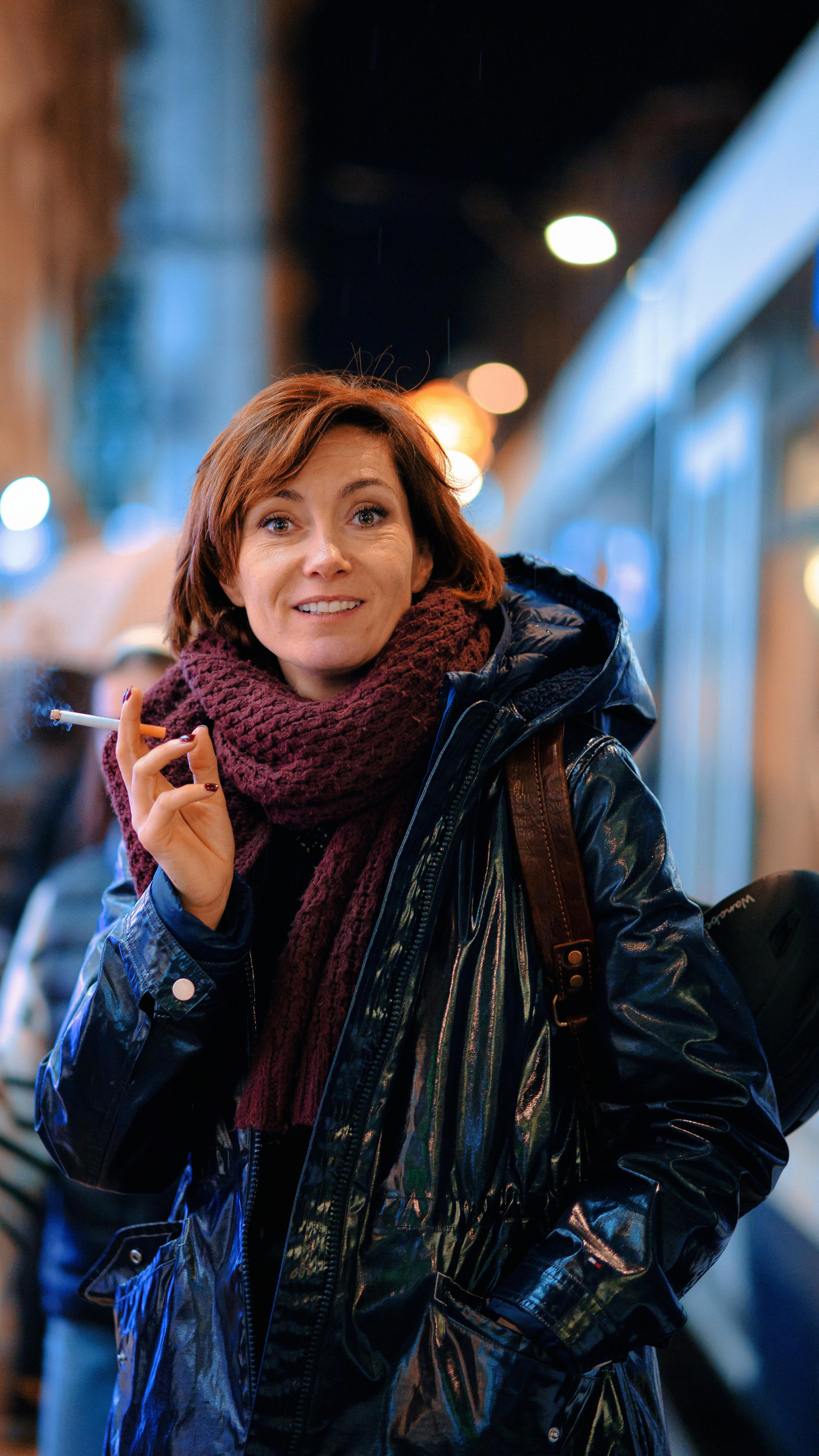 Woman in a Winter Coat Smoking Cigarette · Free Stock Photo
