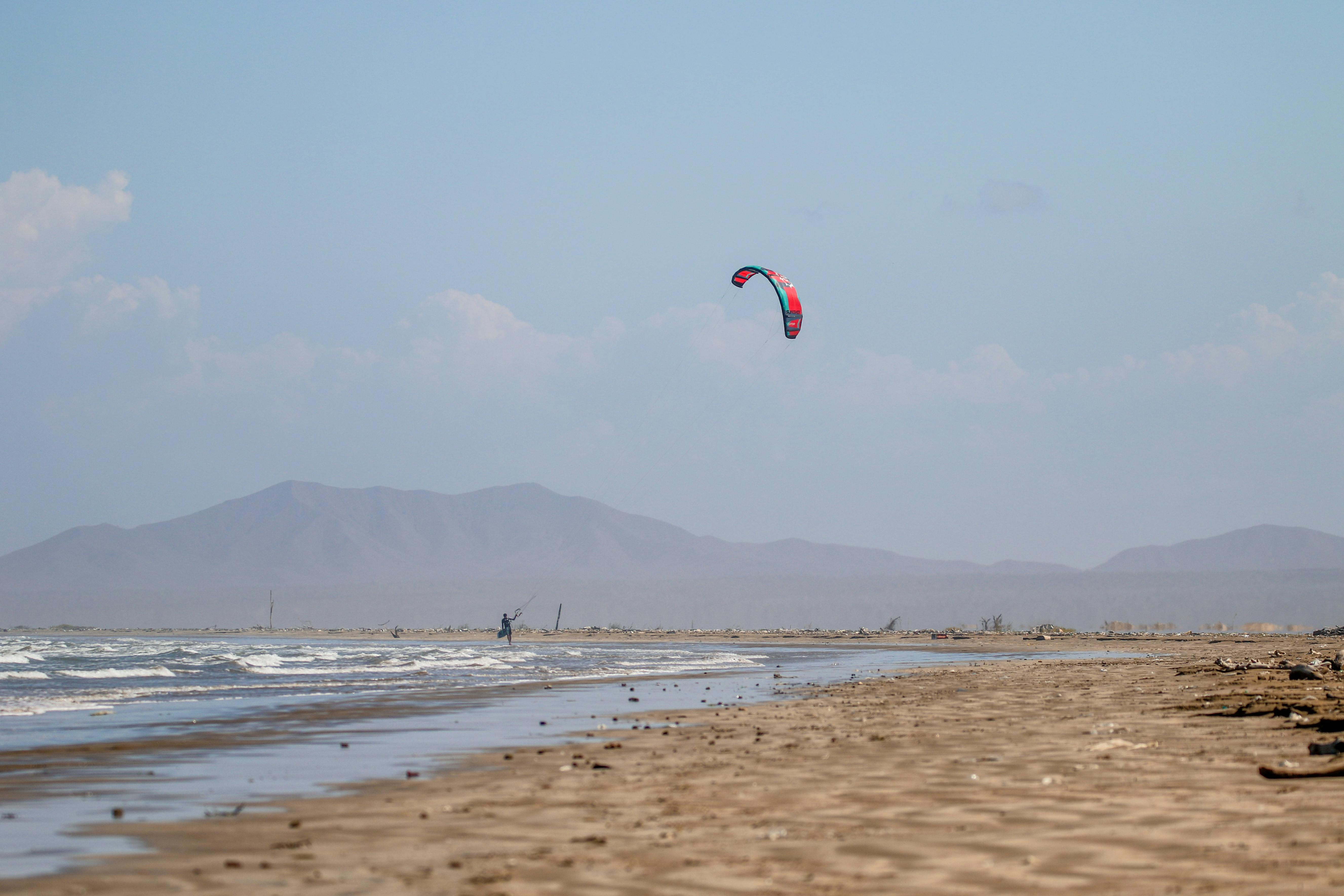 Sandy Beach and Mountains in Mist · Free Stock Photo
