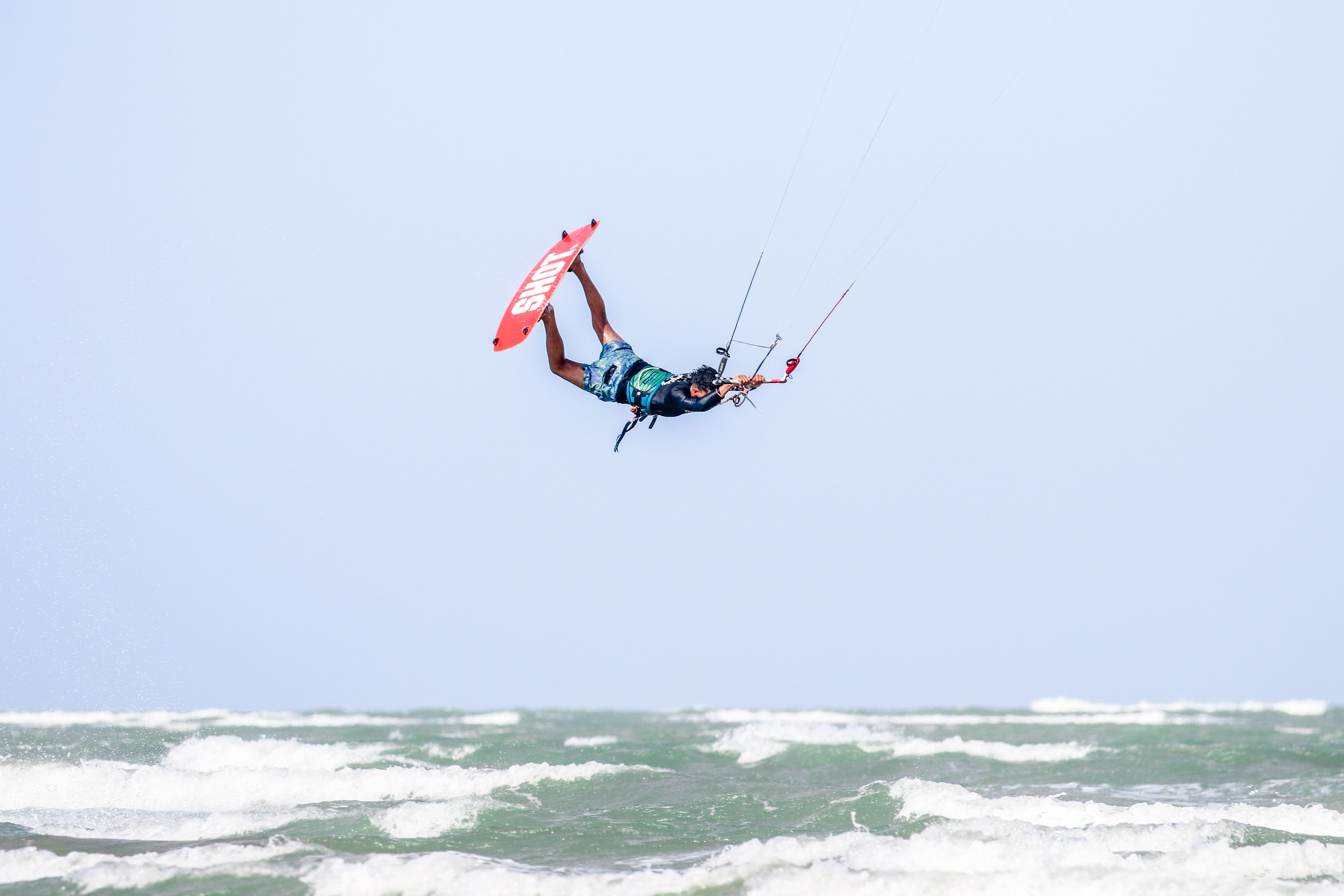 Man Flying above the Sea while Kitesurfing · Free Stock Photo