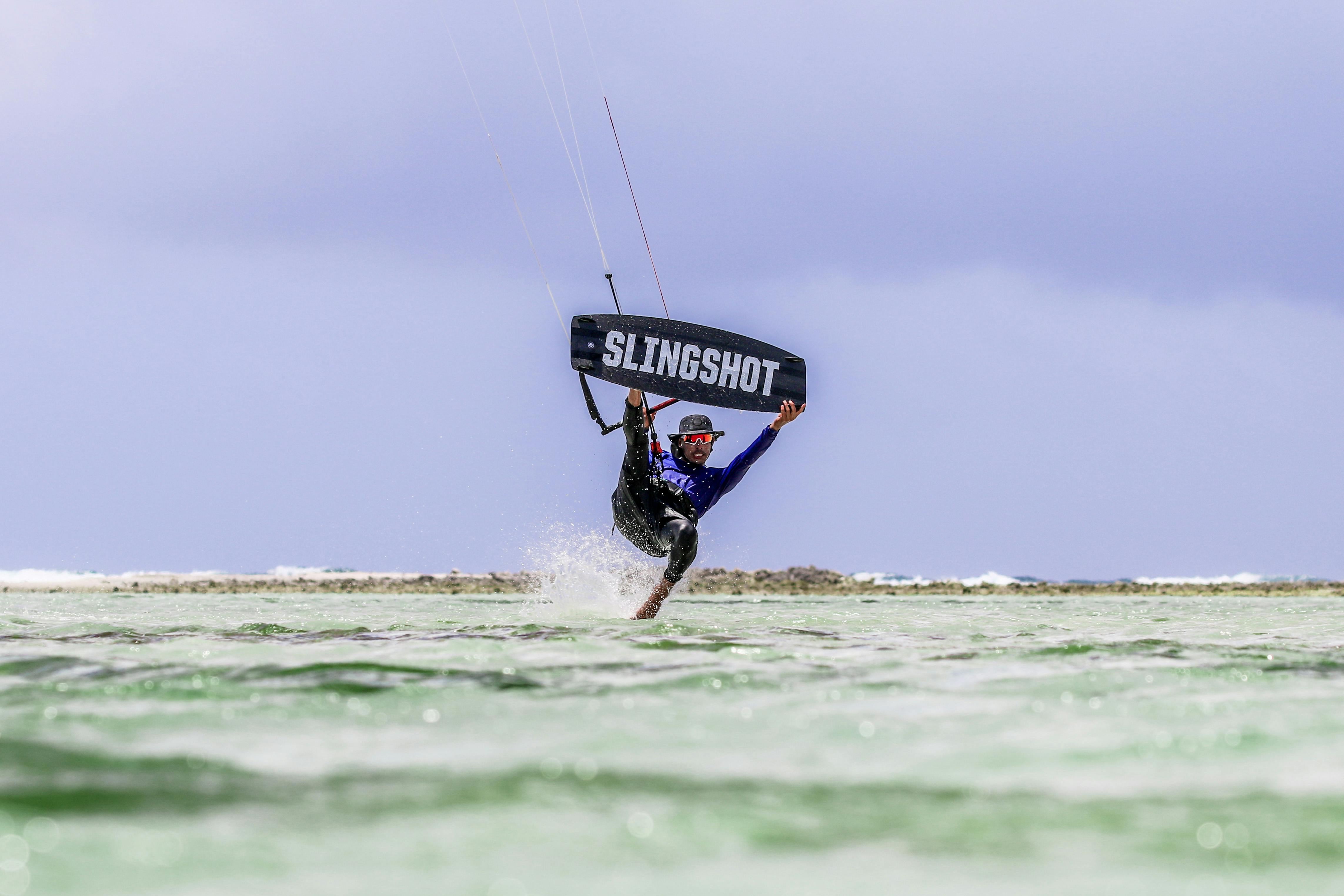 Man in Black Cap Sitting Between Two Hang Gliders on the Beach · Free ...