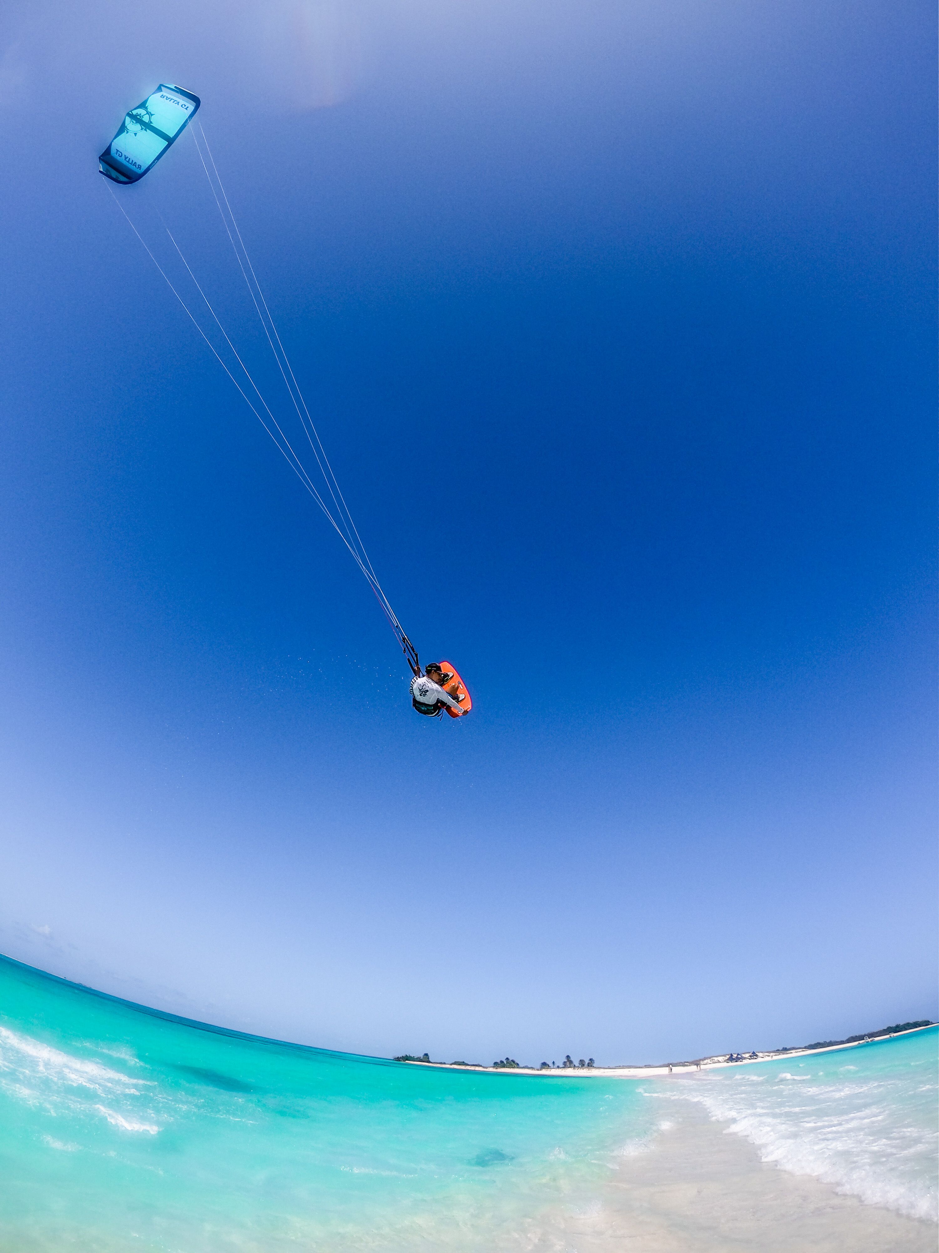 Wide Angle of a Man Flying above the Sea while Kitesurfing · Free Stock ...