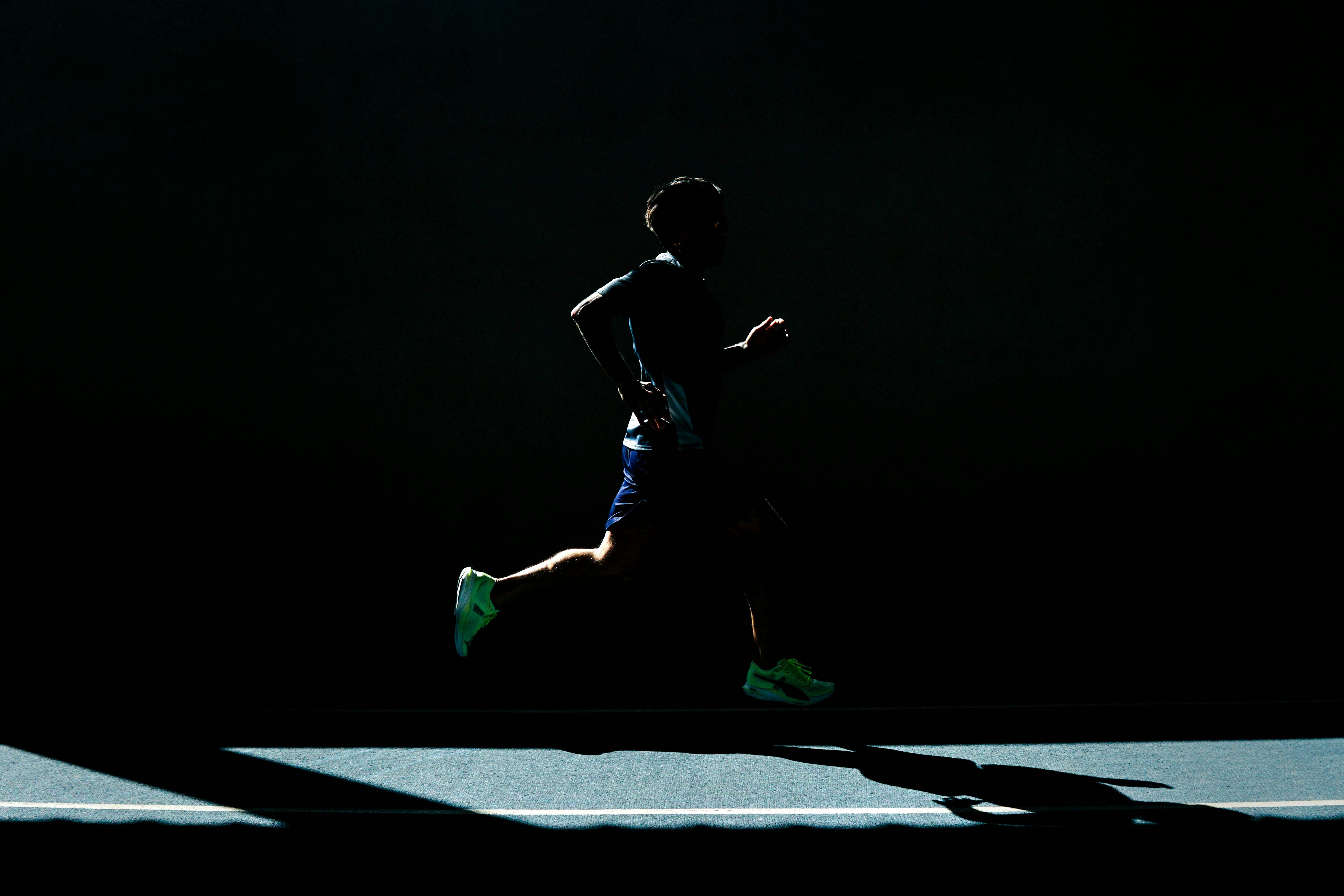 Runner on the Track in Shade · Free Stock Photo