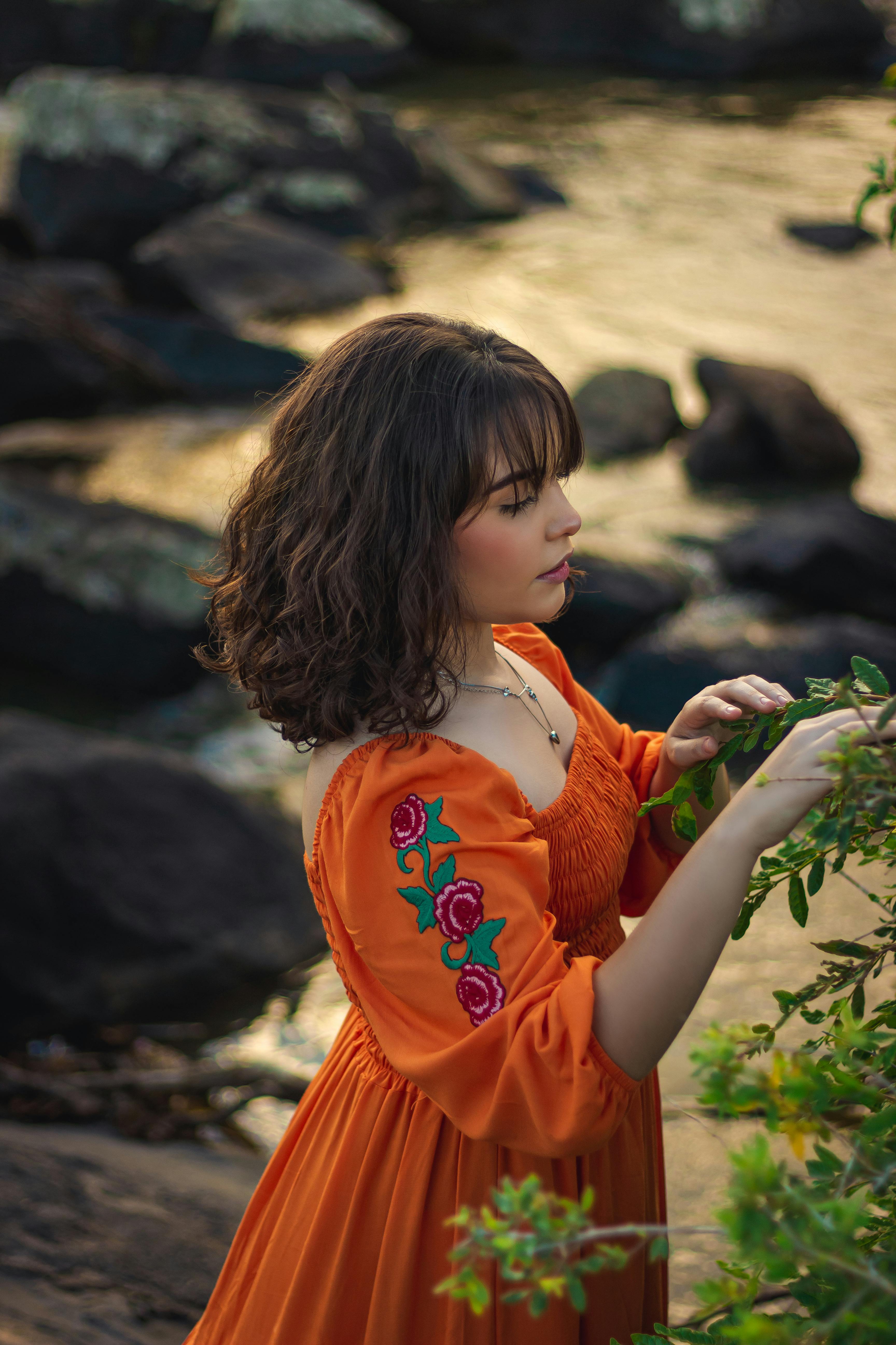 Woman Sitting on Rock and Posing · Free Stock Photo