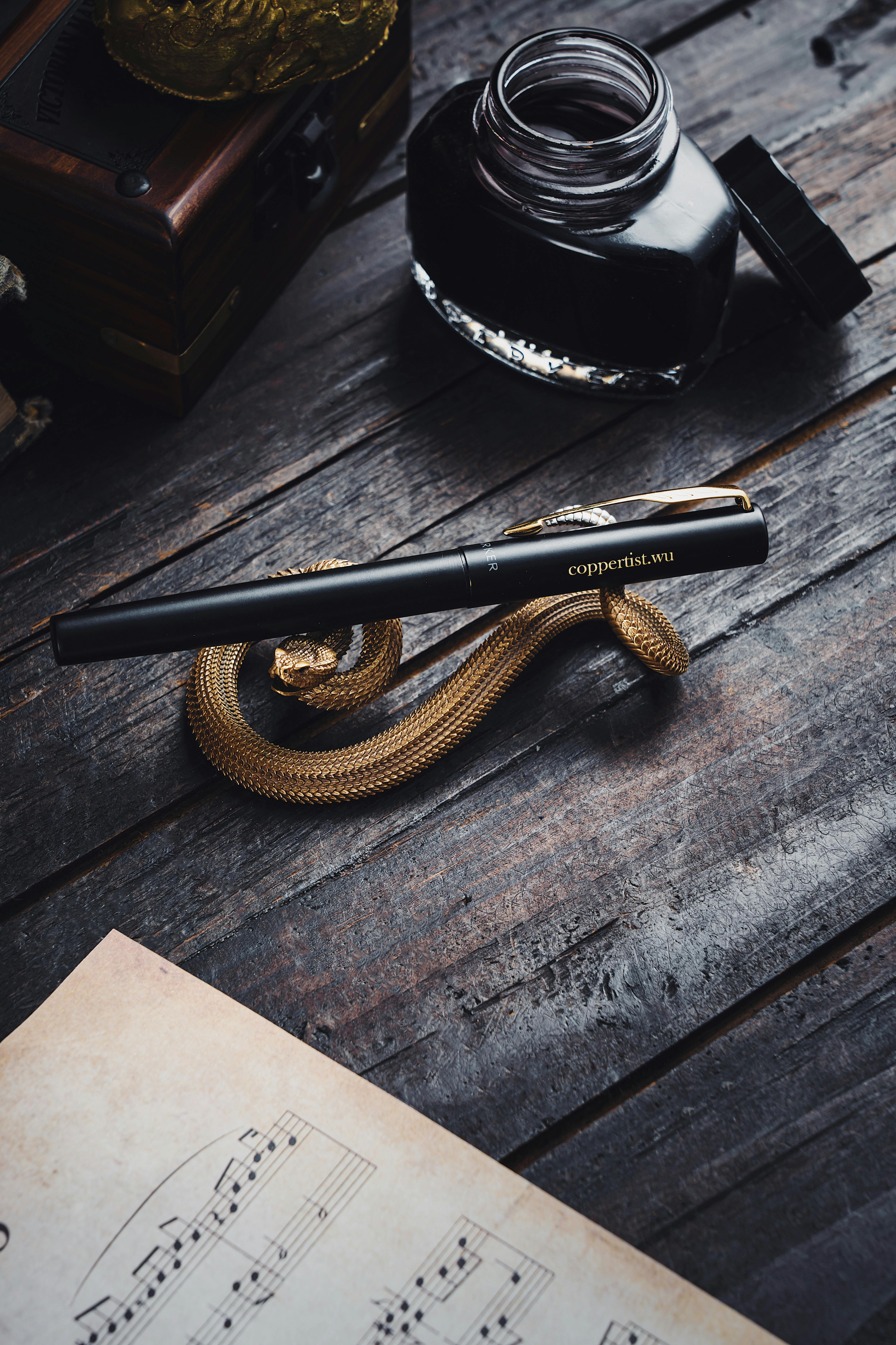 Pen, Ink and Decorative Snake · Free Stock Photo