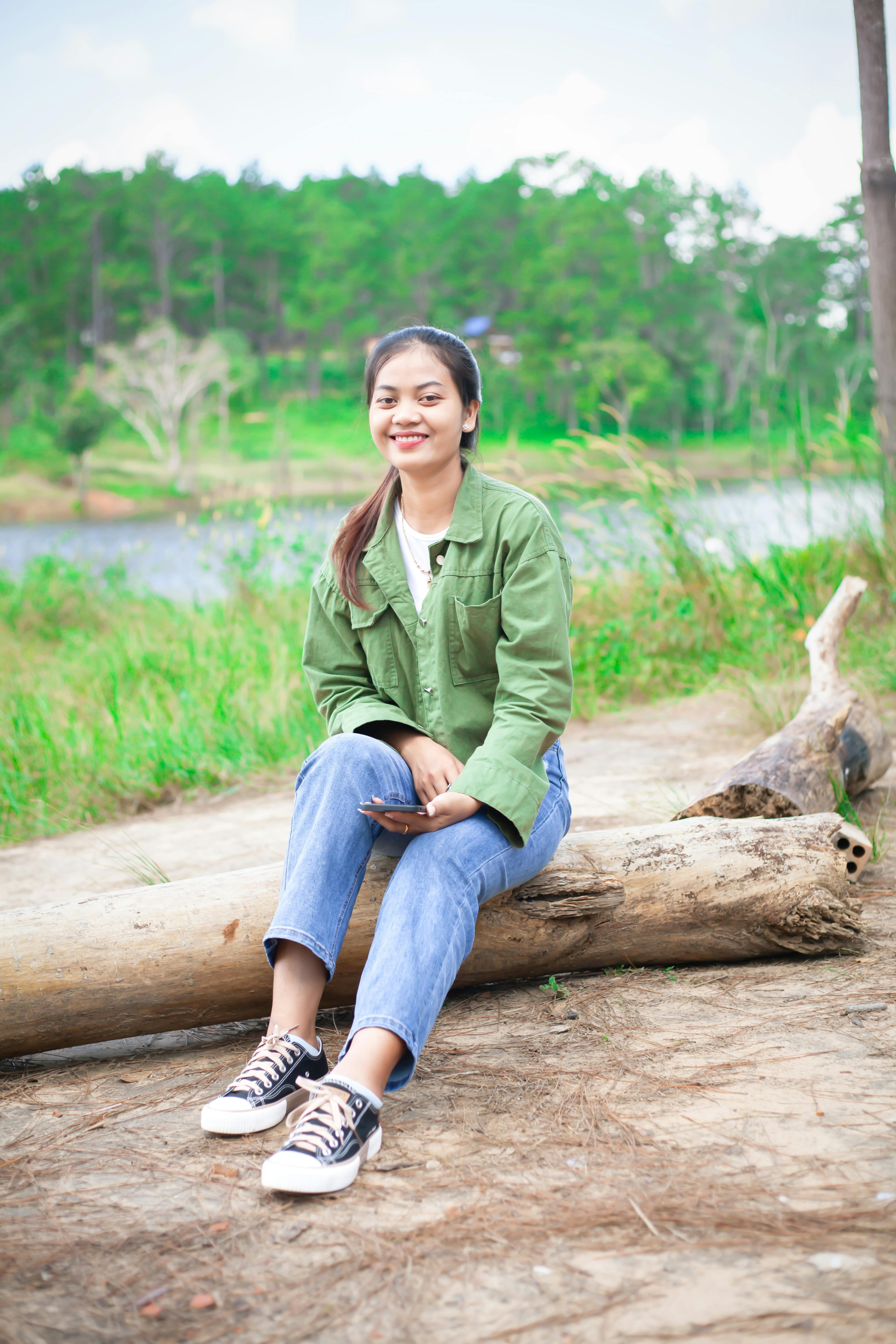 Woman Sitting on Log · Free Stock Photo