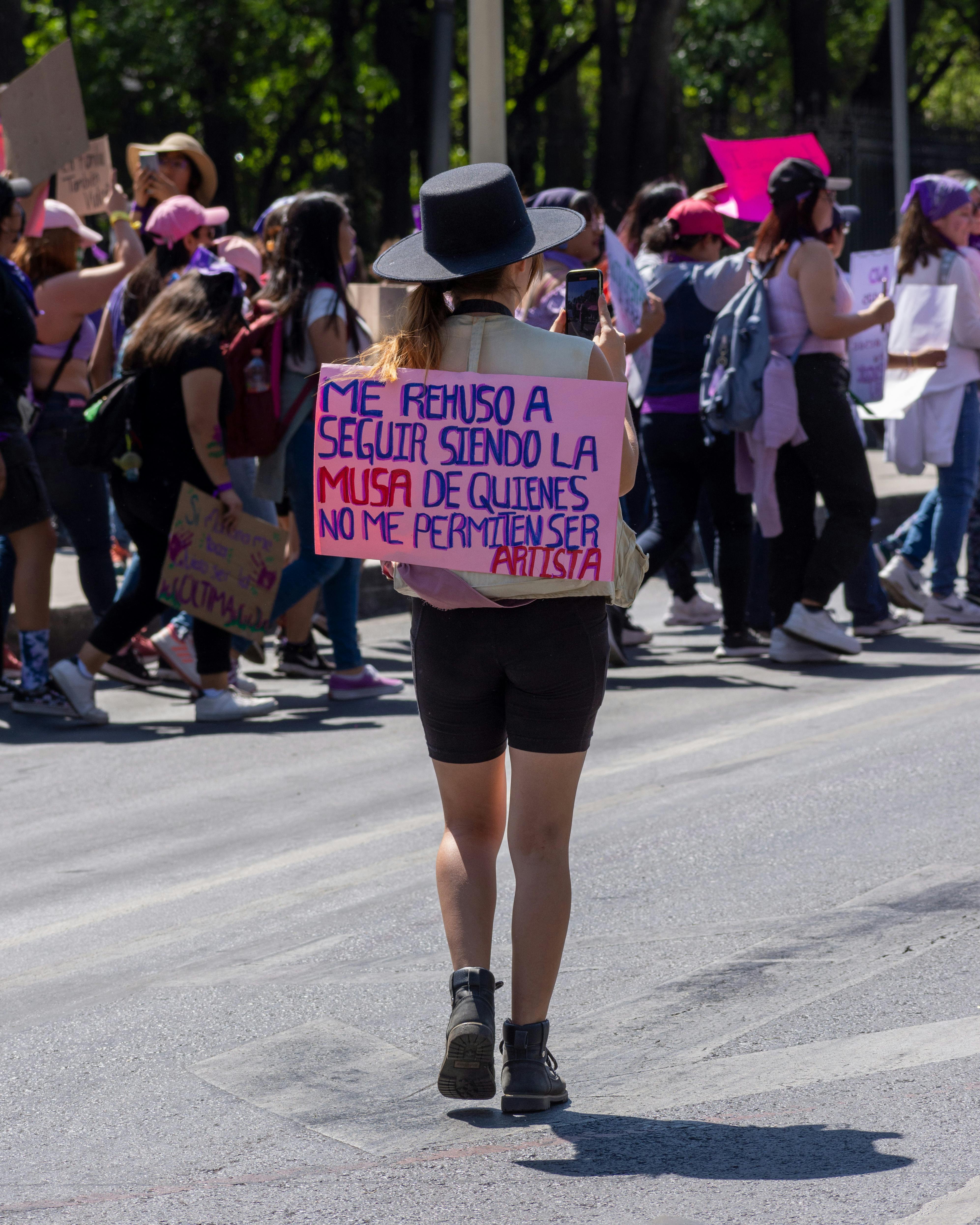 Woman Walking with Sign · Free Stock Photo