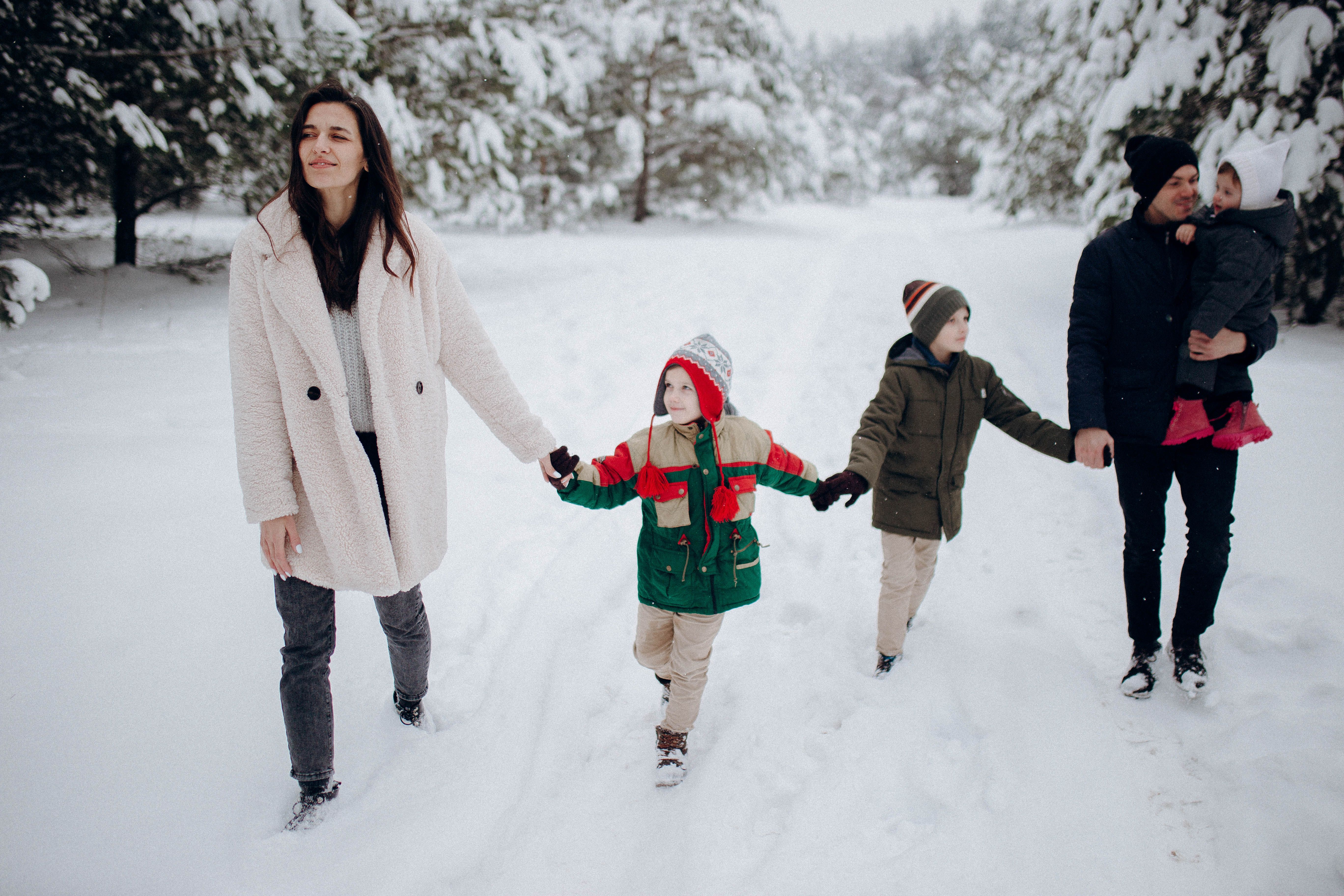 Mother and Father with Children in Snow in Forest · Free Stock Photo