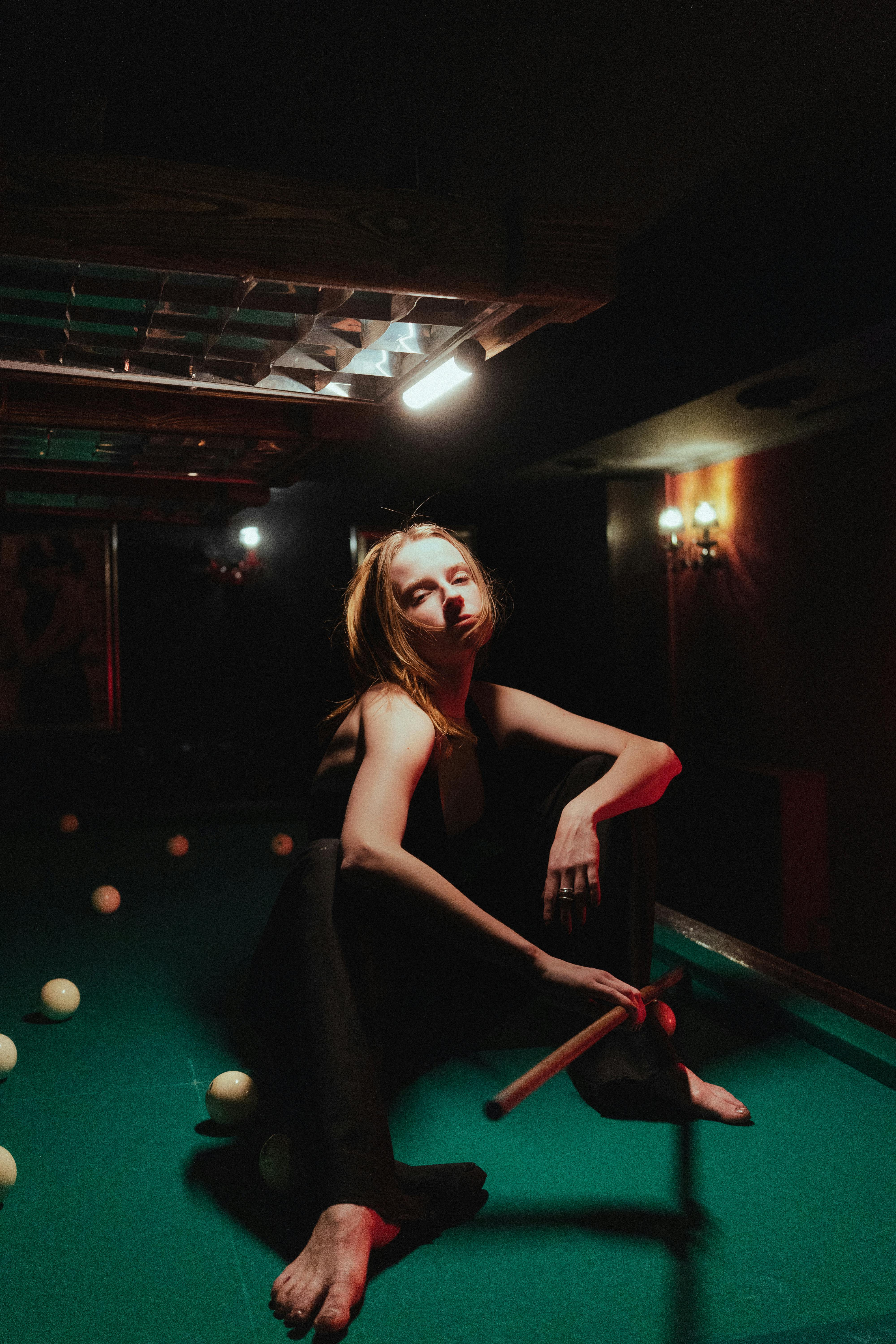Woman Sitting on Pool Table · Free Stock Photo