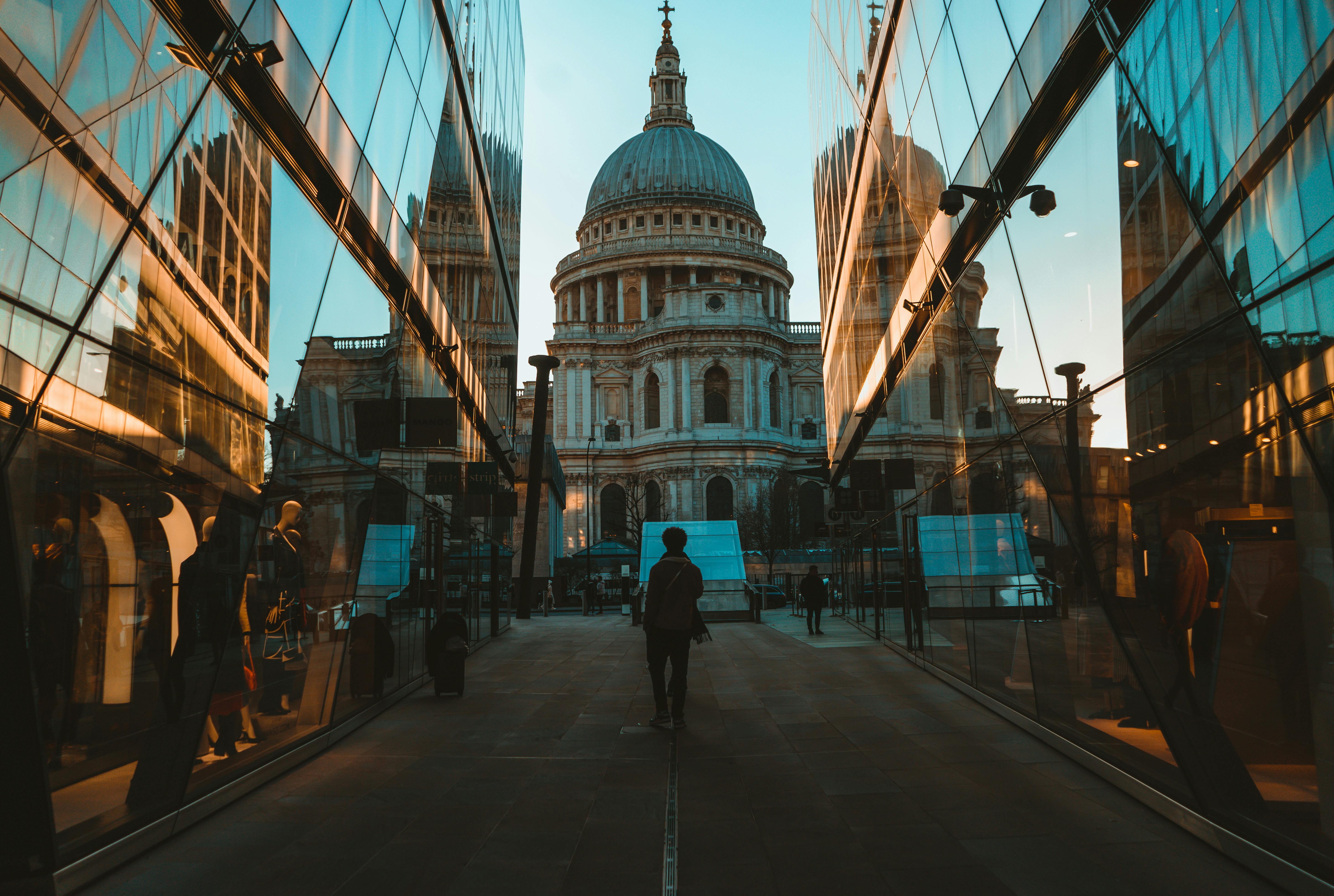Man near Glass Modern Buildings close to Historical Cathedral · Free ...