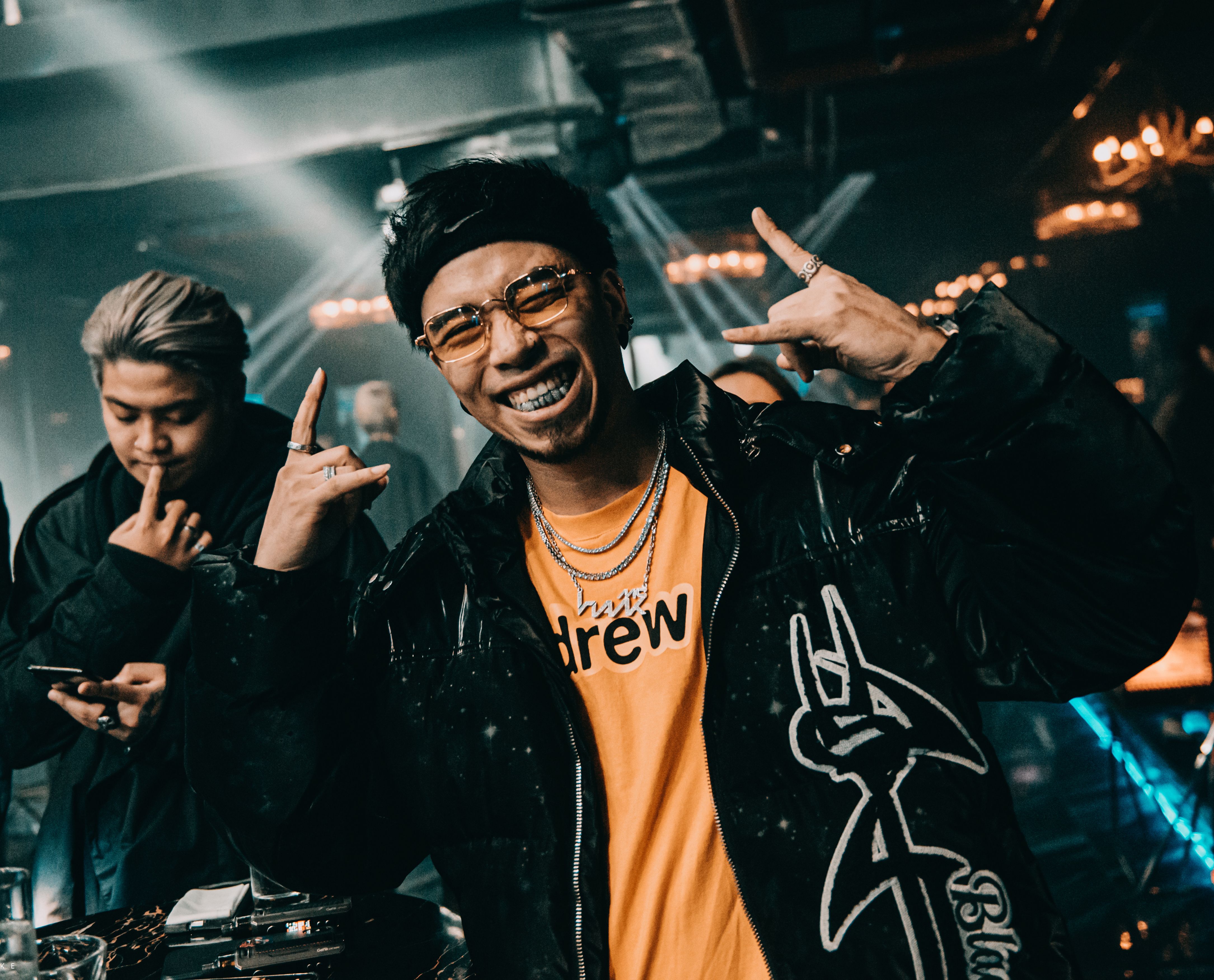 Smiling Man in Street Wear Posing in Nightclub · Free Stock Photo