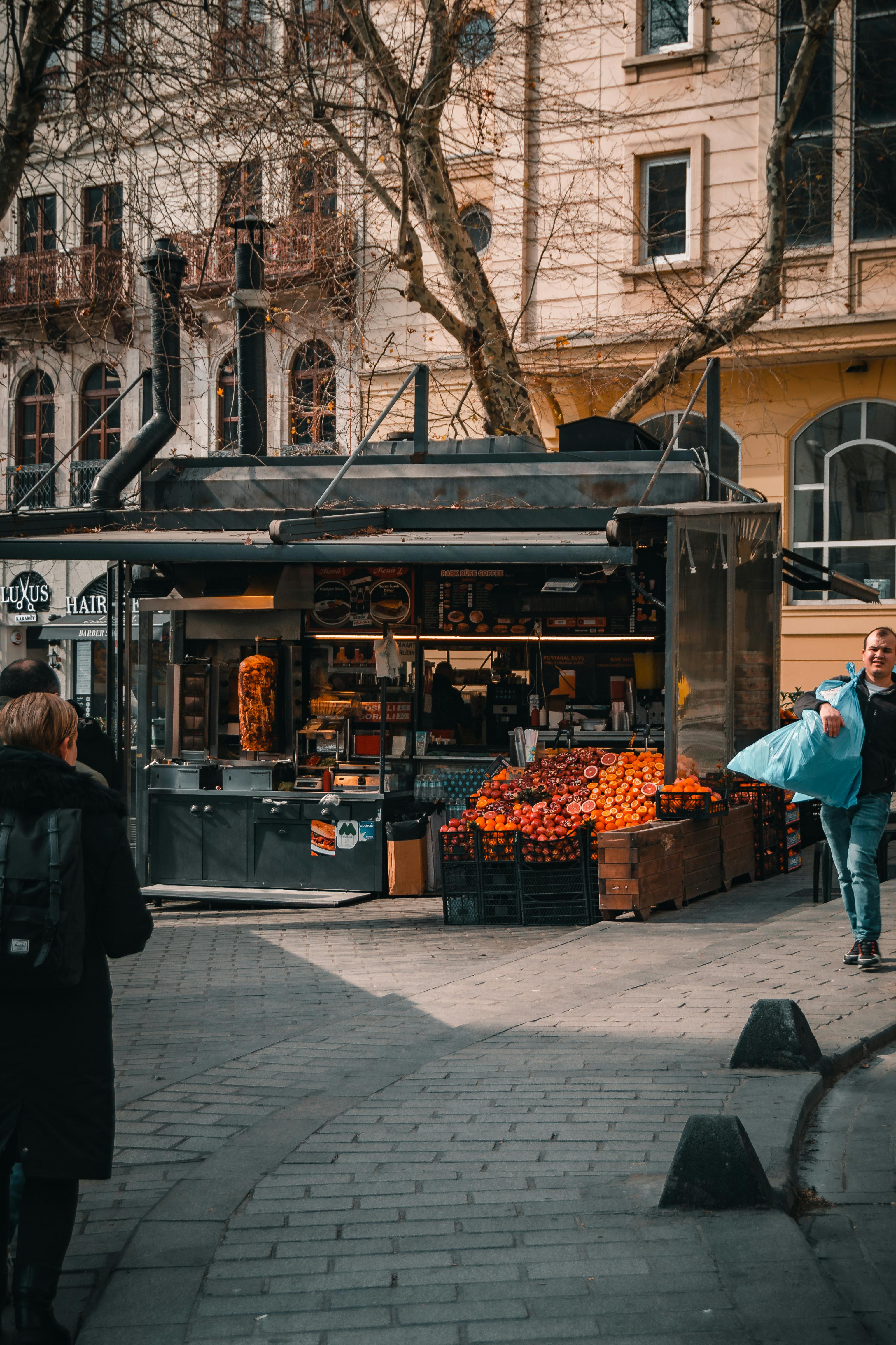 Street Food Stall next to Restaurant at Night · Free Stock Photo