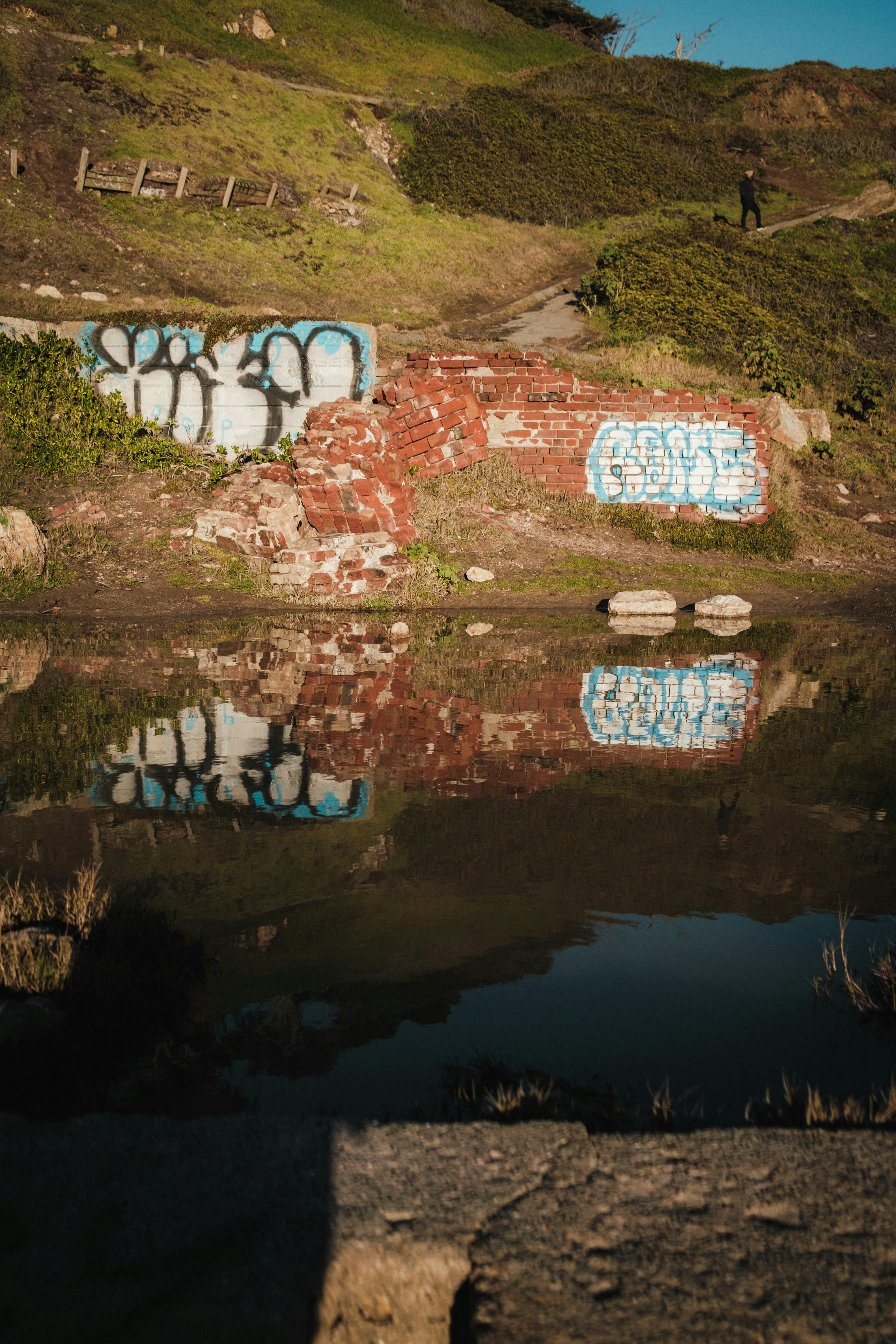 Graffiti on Wall over Lake · Free Stock Photo