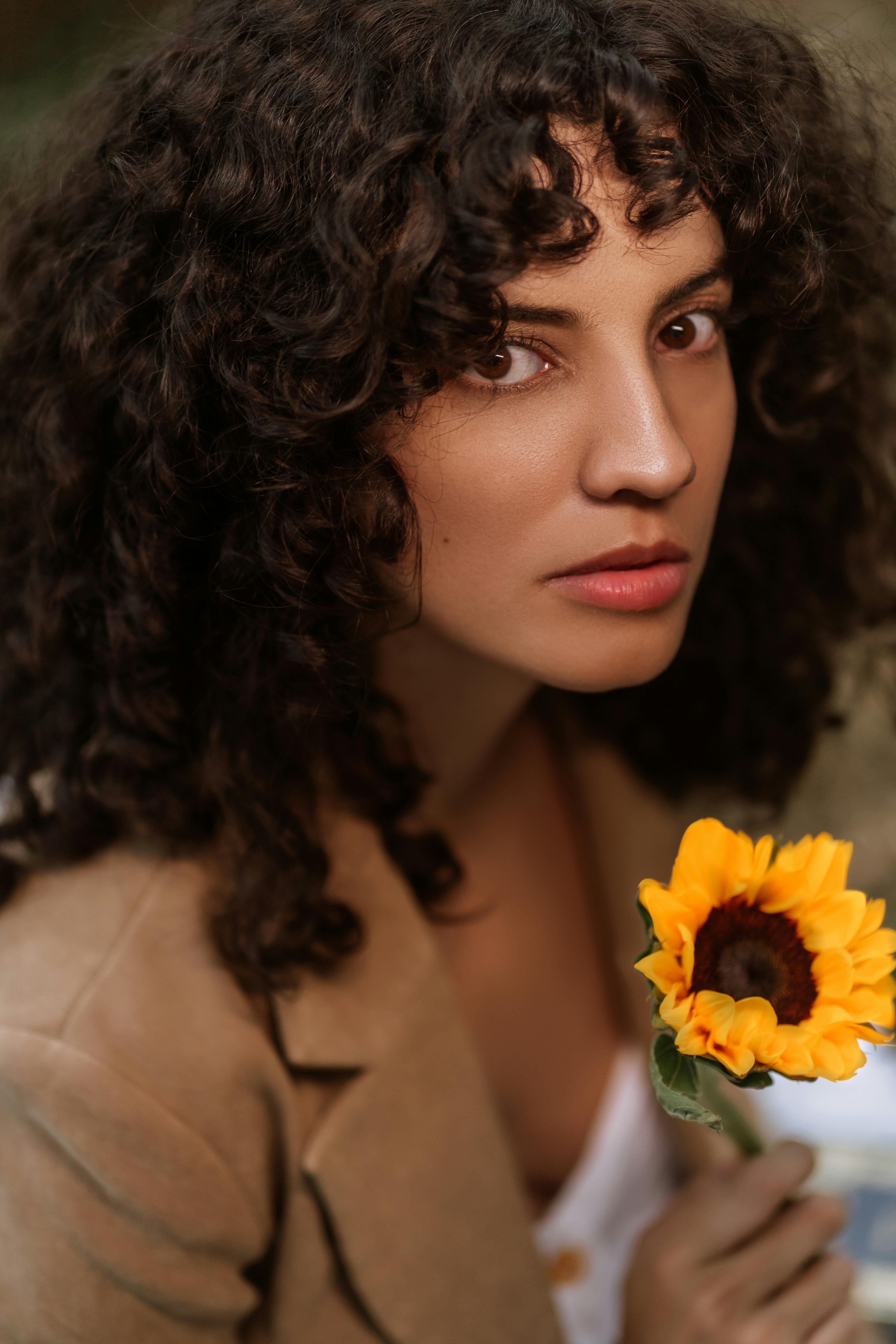 Portrait of a Woman with a Sunflower · Free Stock Photo