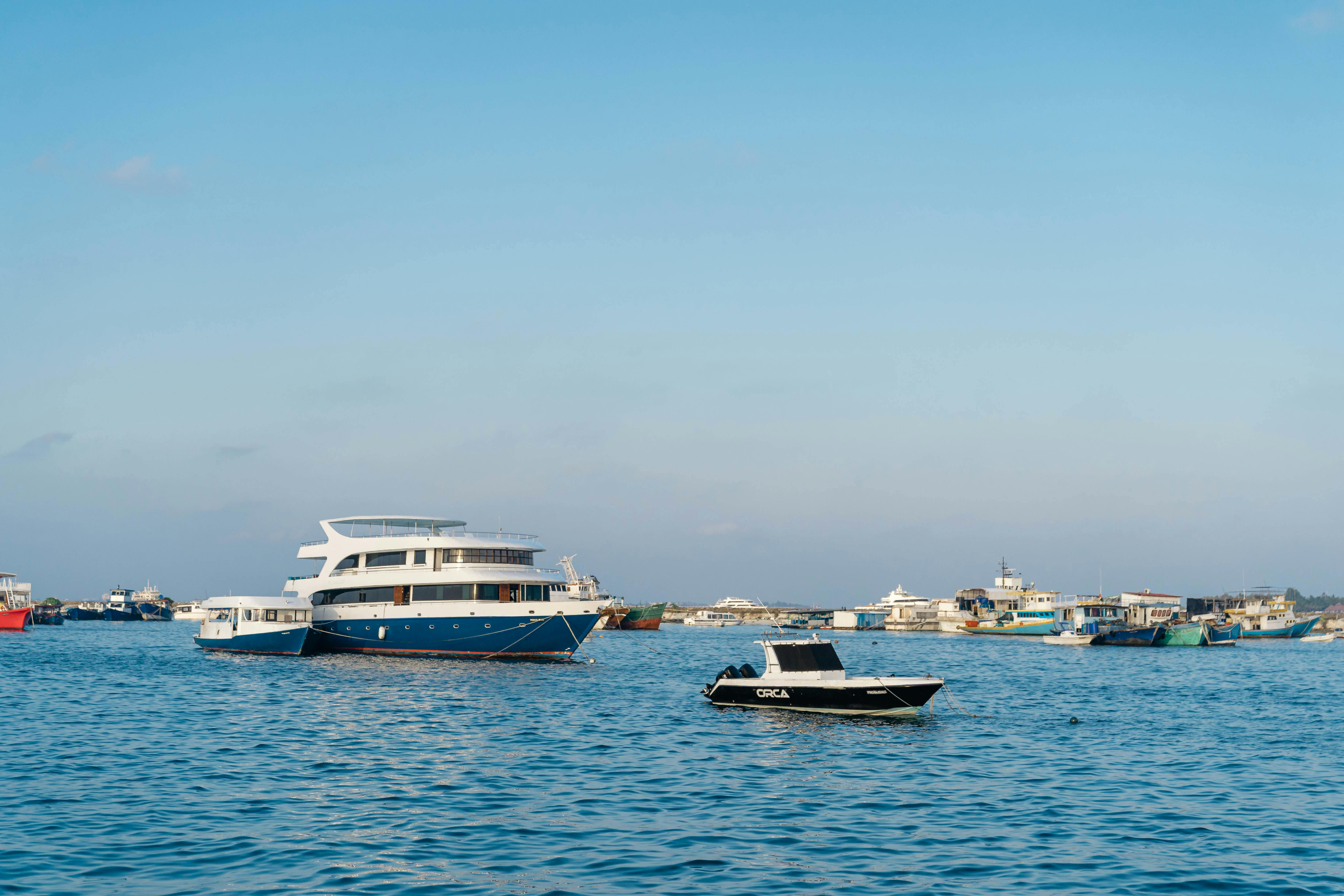 Ferries Sailing on Sea under Blue Sky · Free Stock Photo
