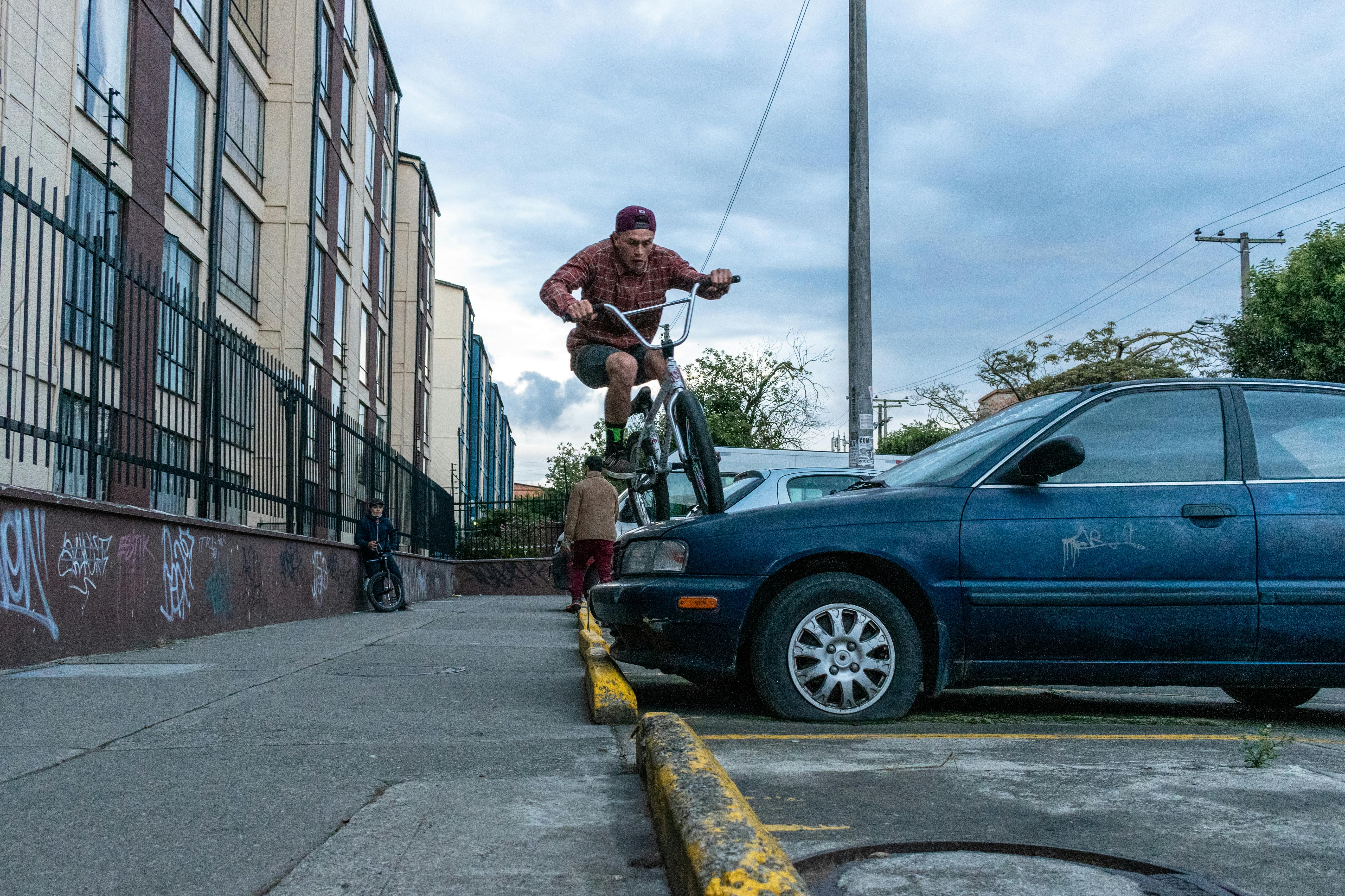 Man Riding a Bike on a Bench · Free Stock Photo
