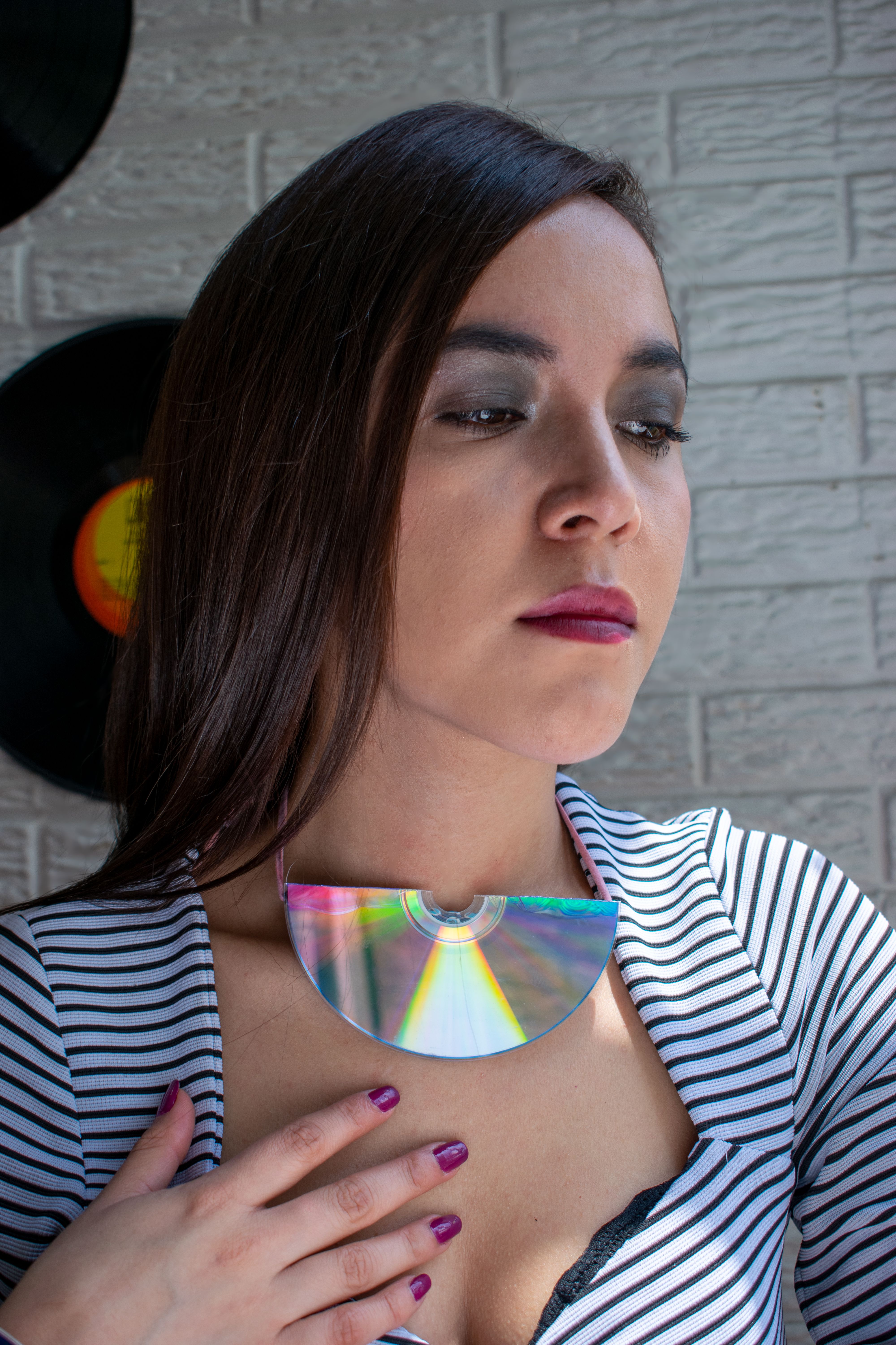 Young Woman in Makeup Wearing an Necklace with Half of a CD and ...