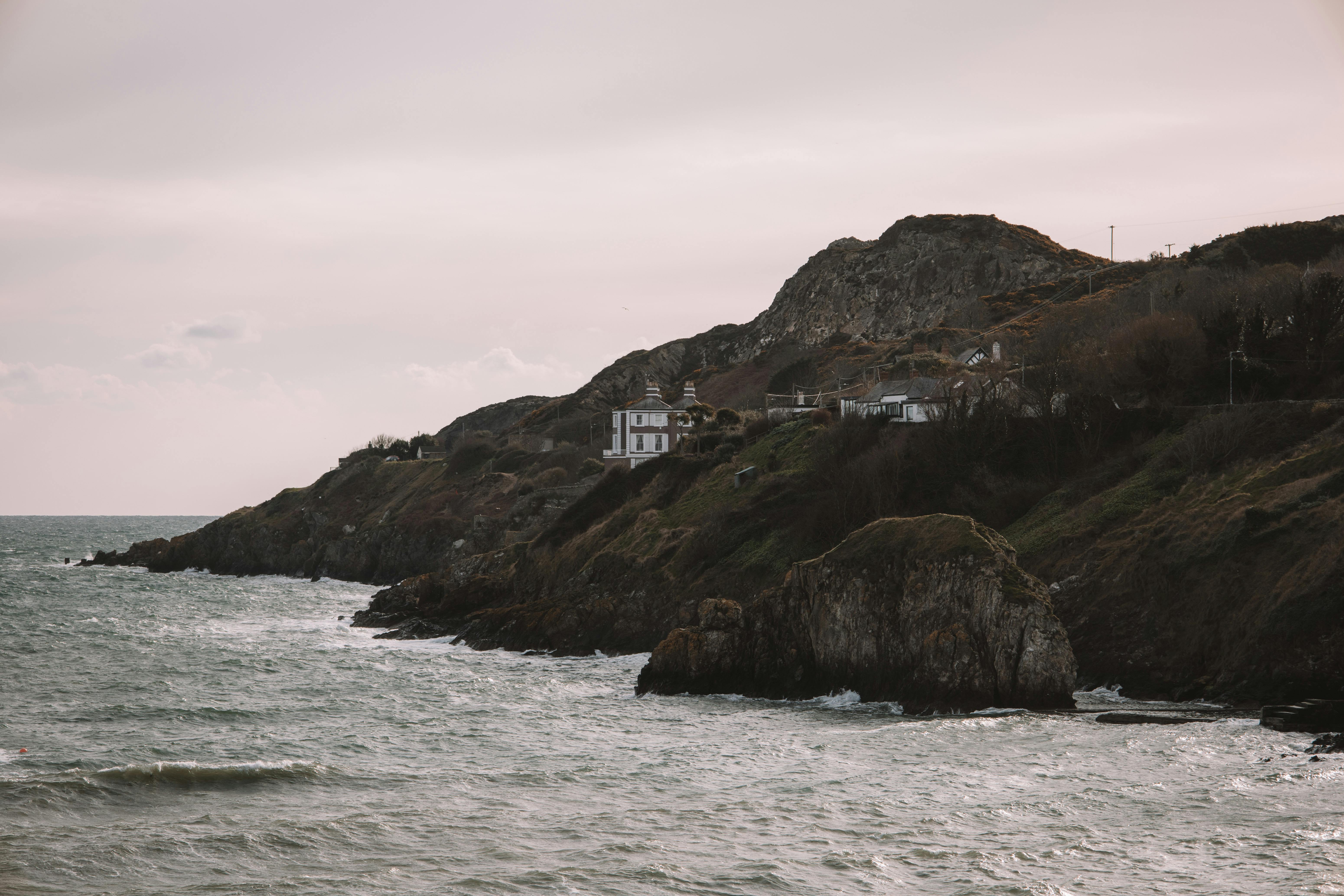 Buildings on Rocks at Seashore · Free Stock Photo
