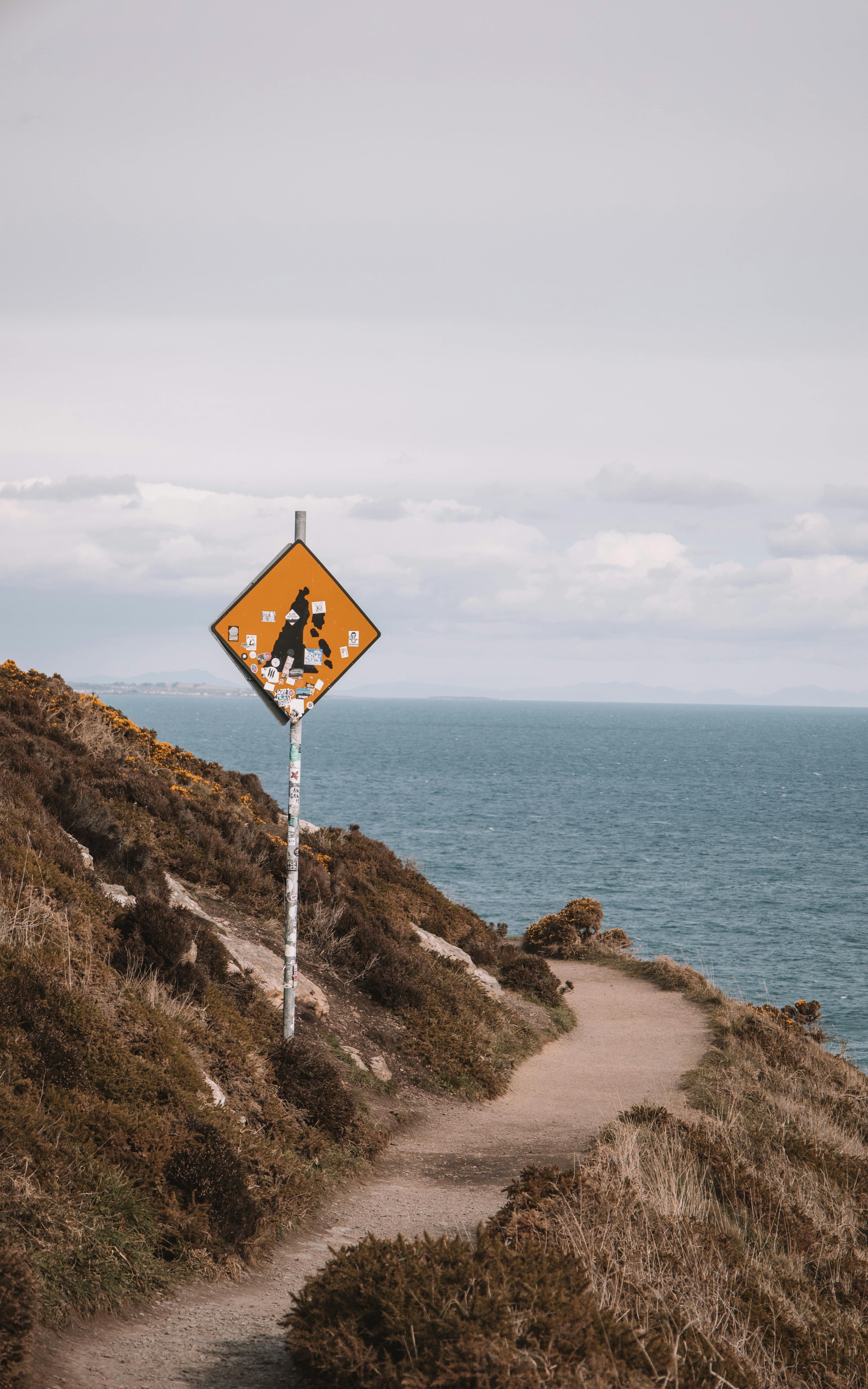 Warning Sign by Footpath on Seashore · Free Stock Photo