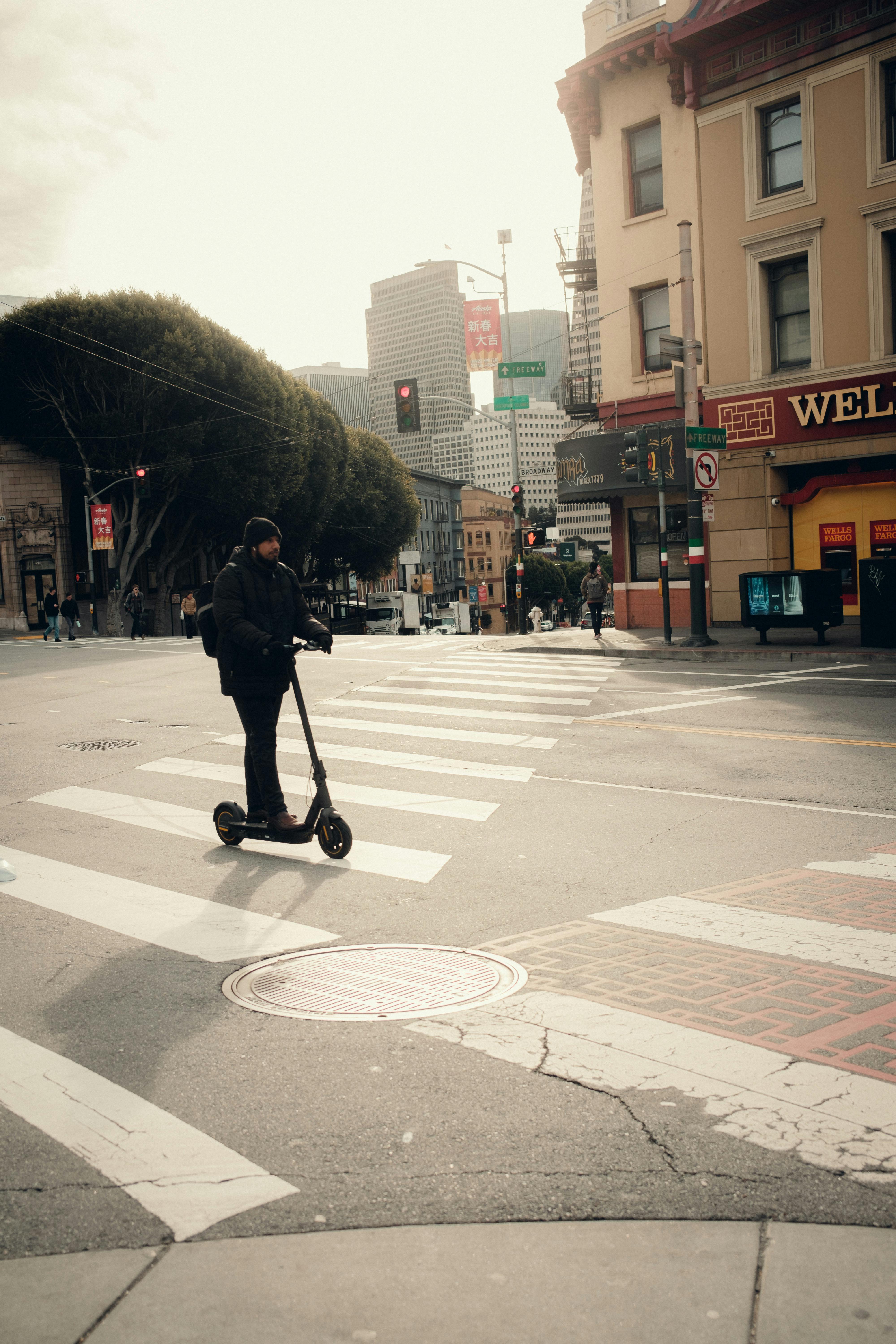Man on Scooter Commuting in City · Free Stock Photo