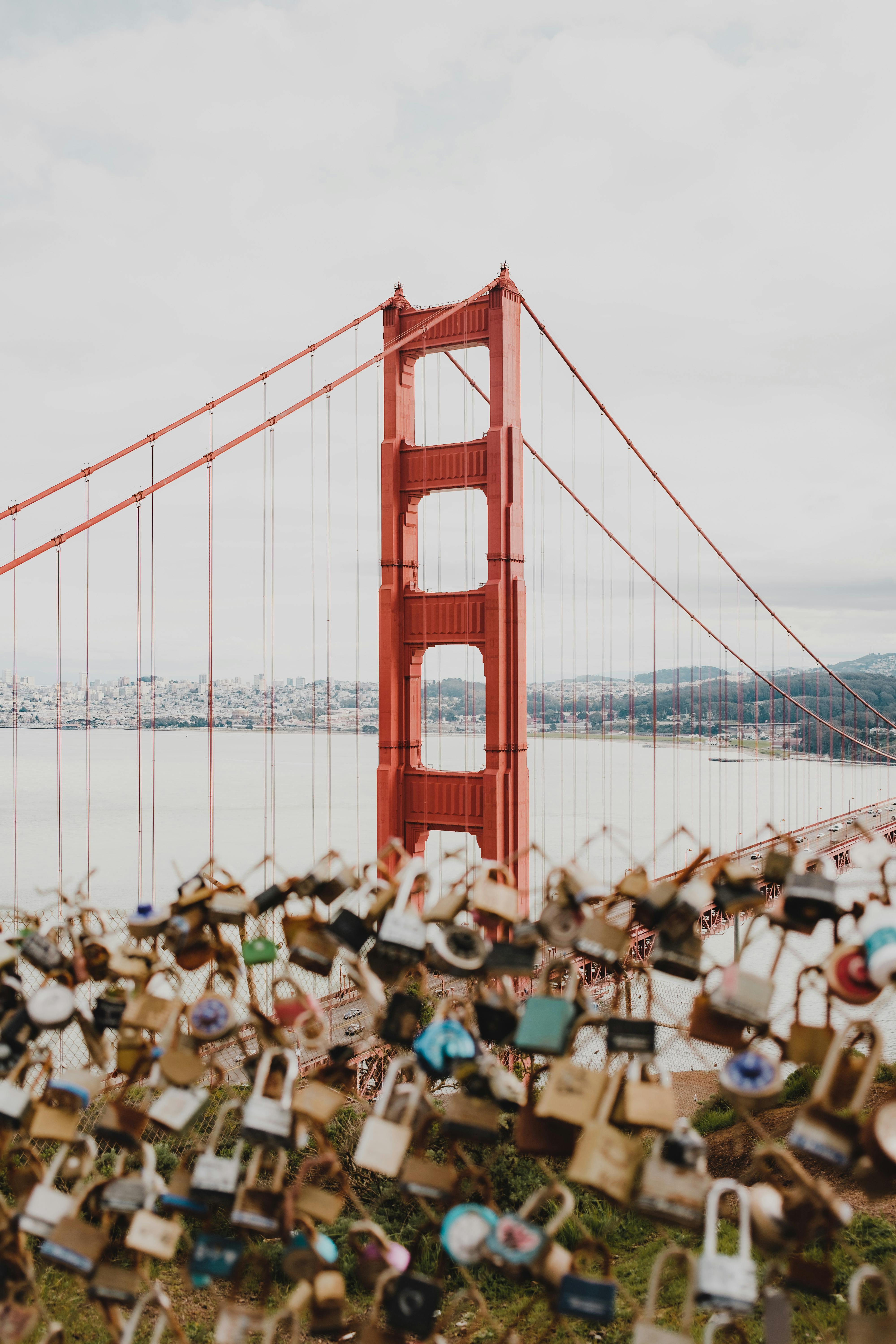 Red Suspension Bridge and Lockers Attached in Foreground · Free Stock Photo