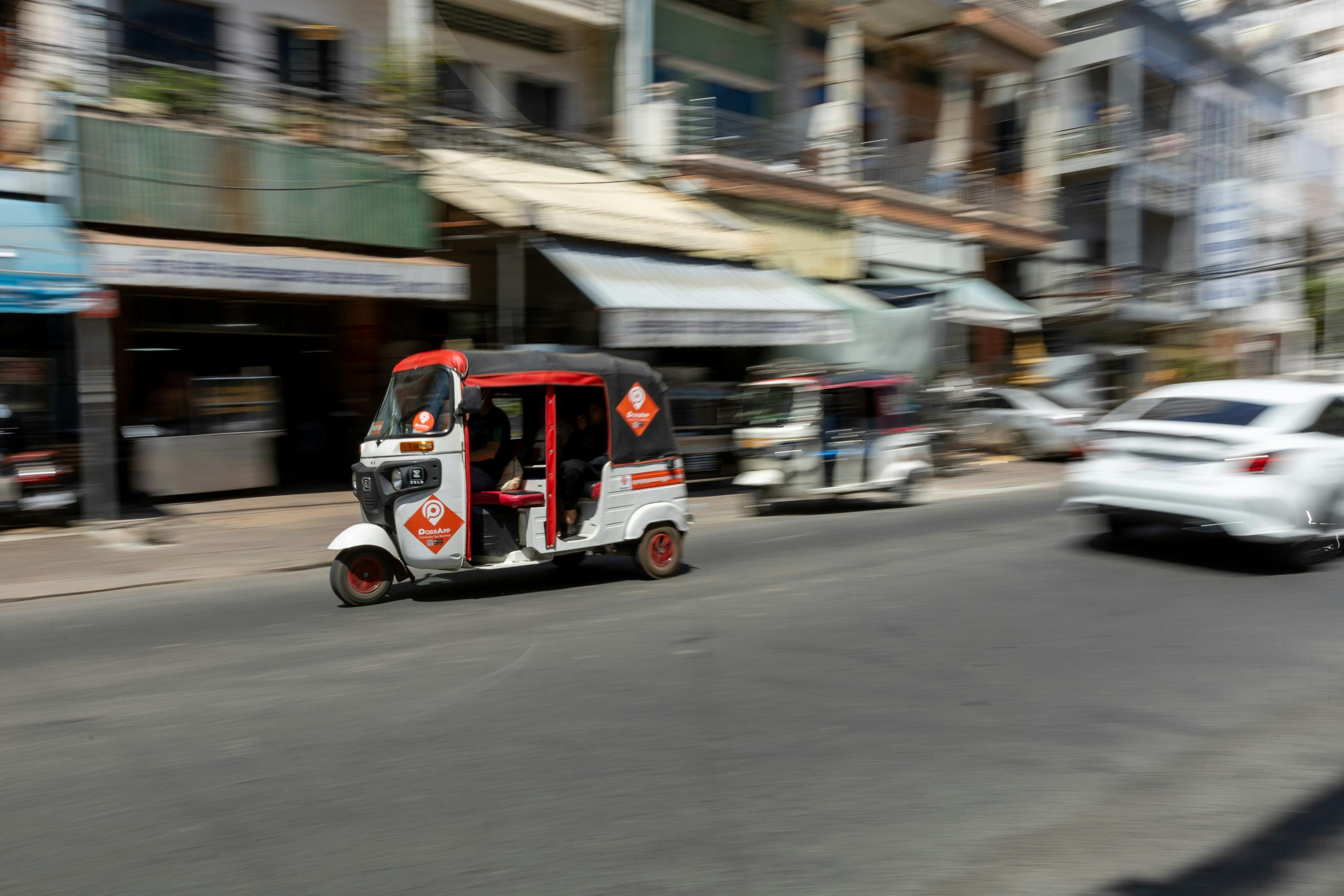 Men Walking on Street with Auto Rickshaws behind · Free Stock Photo