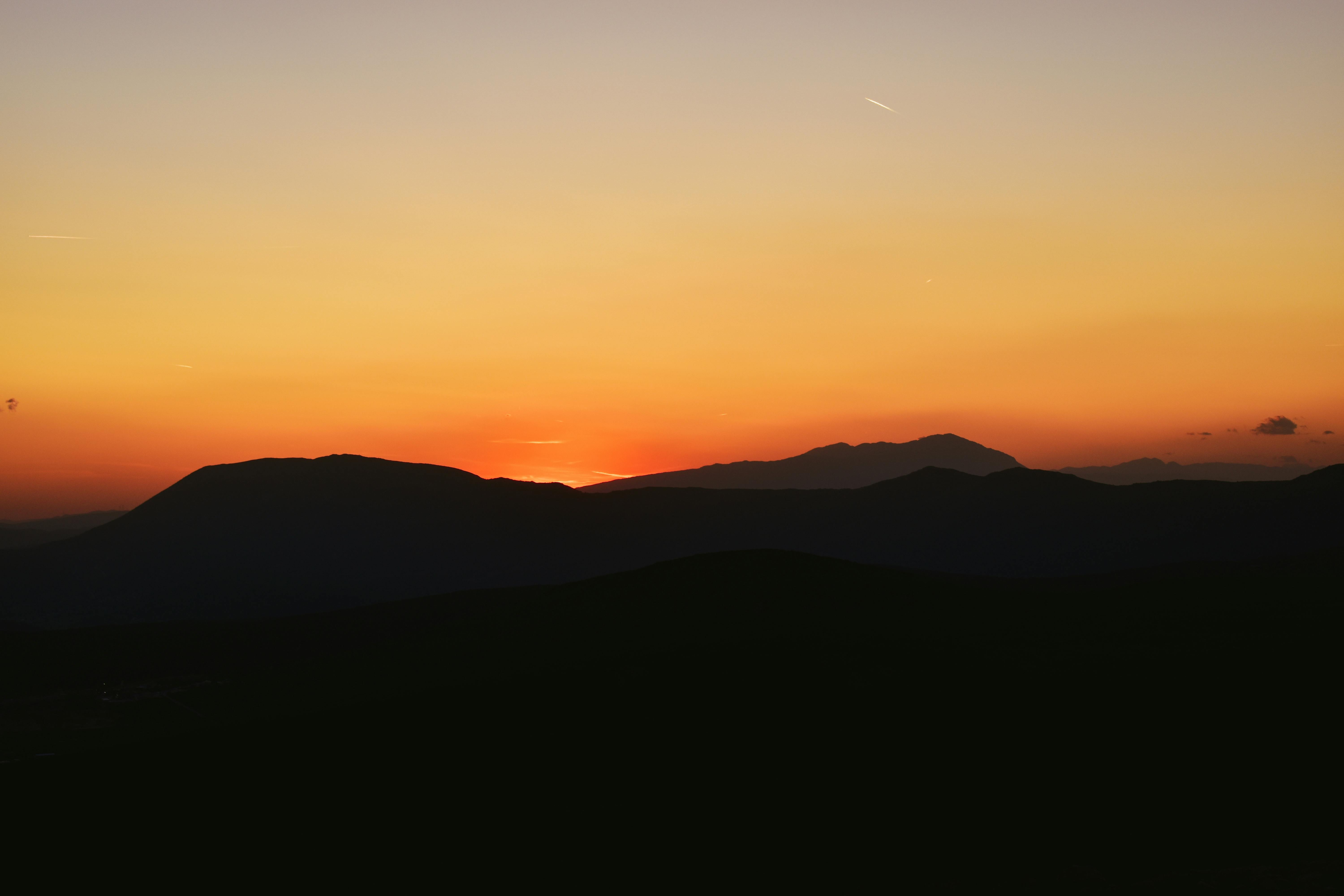 Silhouette of Hills at Sunset · Free Stock Photo