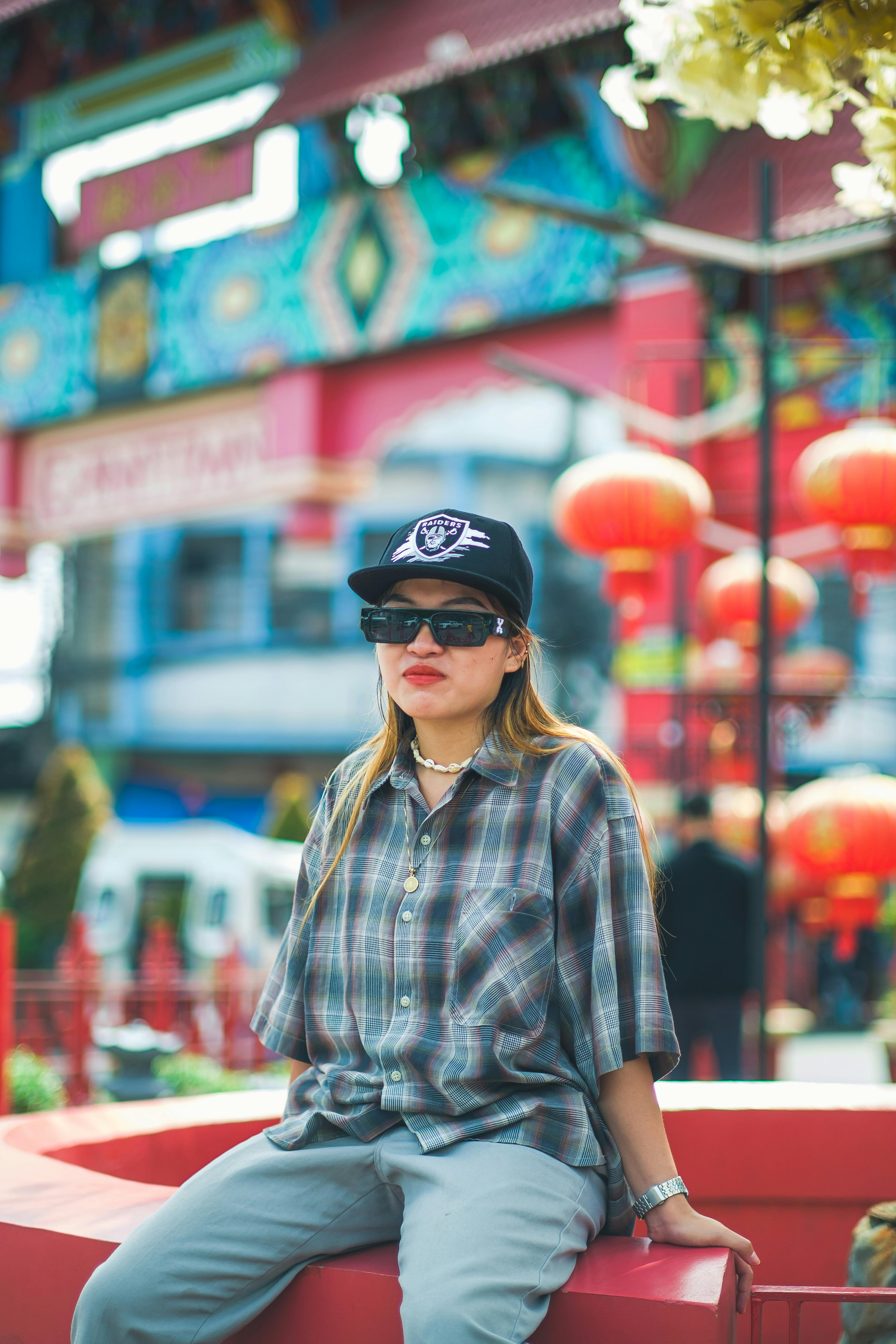 Woman Sitting and Posing in Shirt and Cap · Free Stock Photo