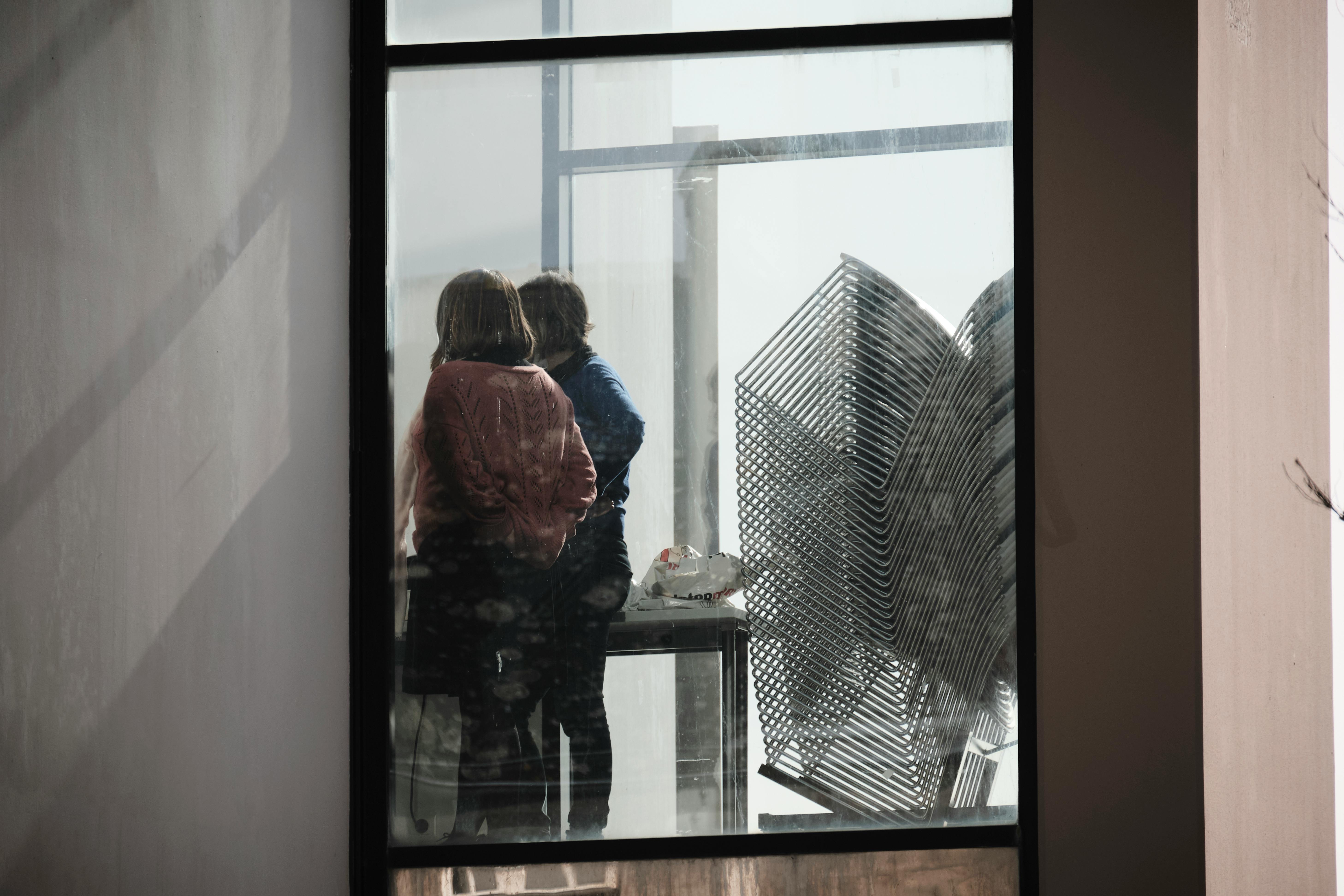 Women Standing behind Glass · Free Stock Photo