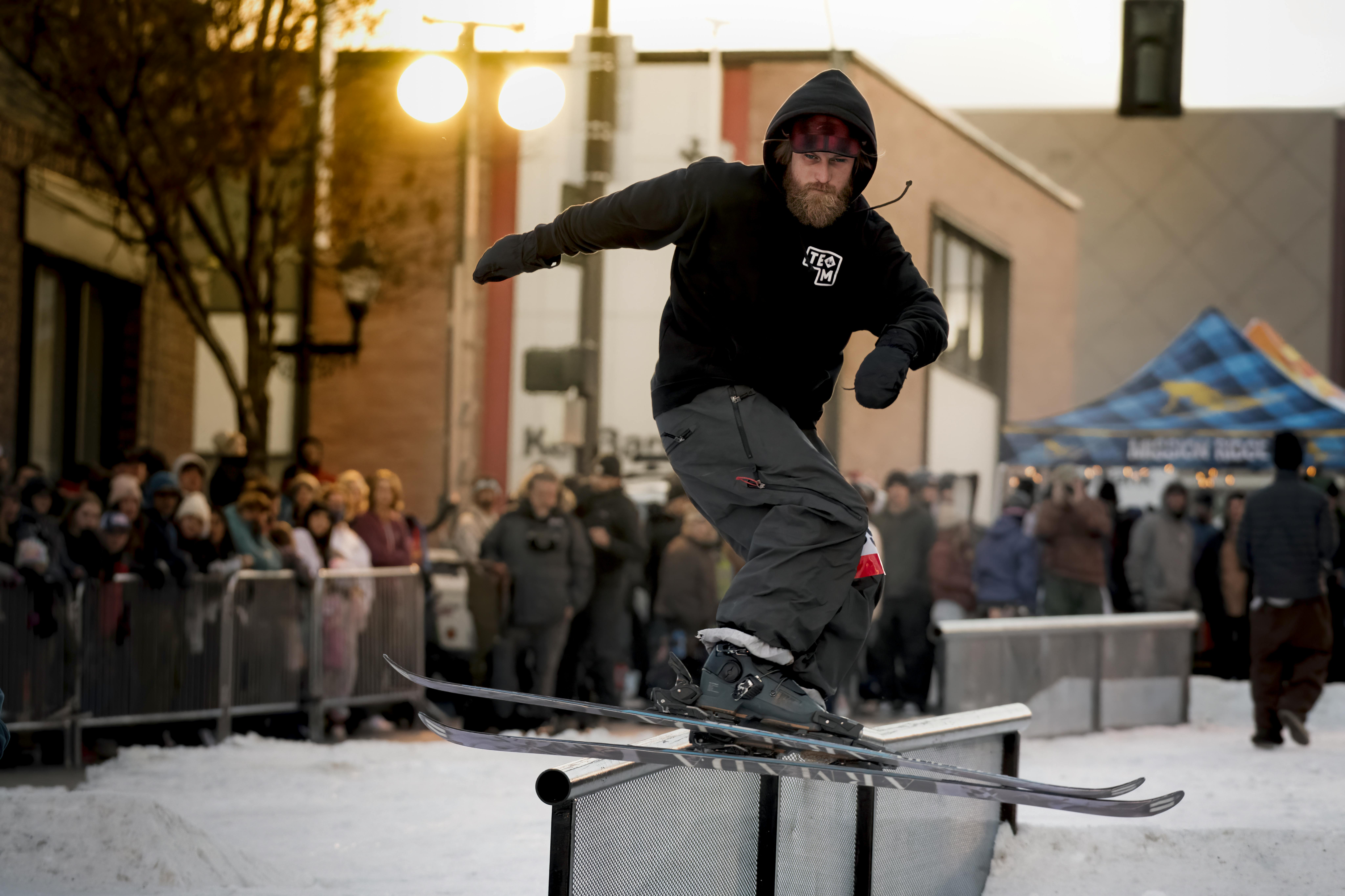 A man on a snowboard doing tricks on a rail · Free Stock Photo