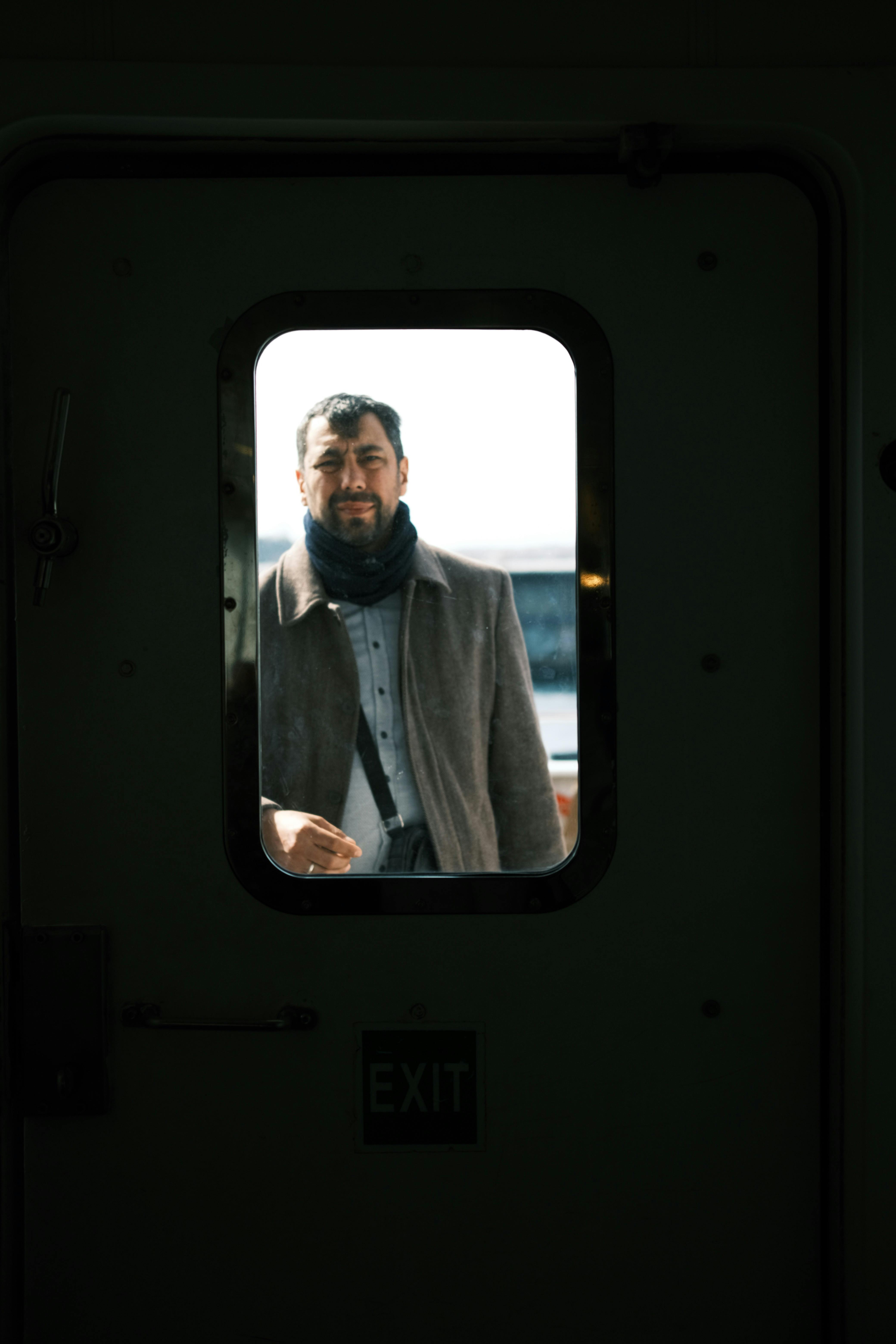 Man Seen through Window on Ferry · Free Stock Photo