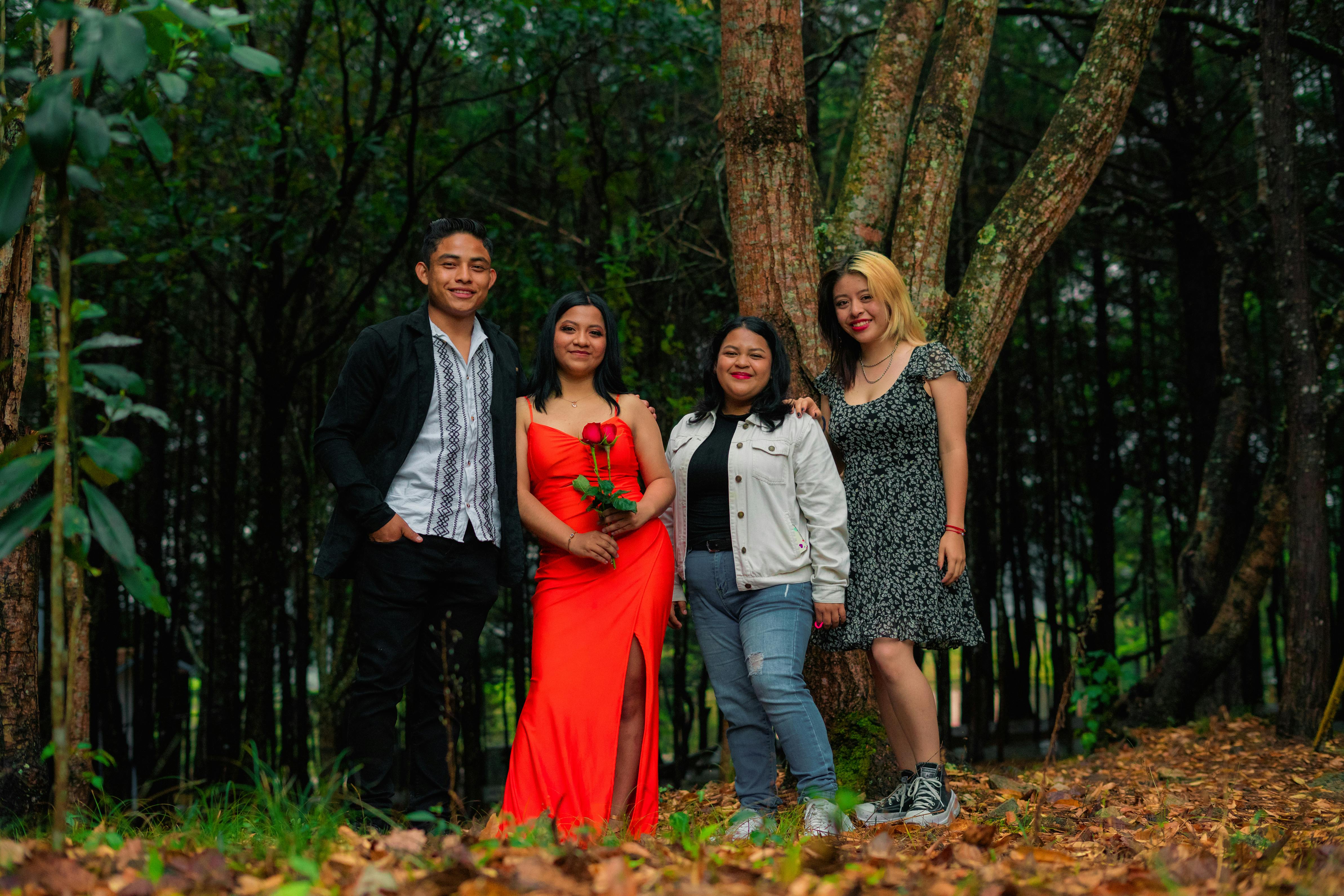 Couple Posing with Friends Under Trees · Free Stock Photo