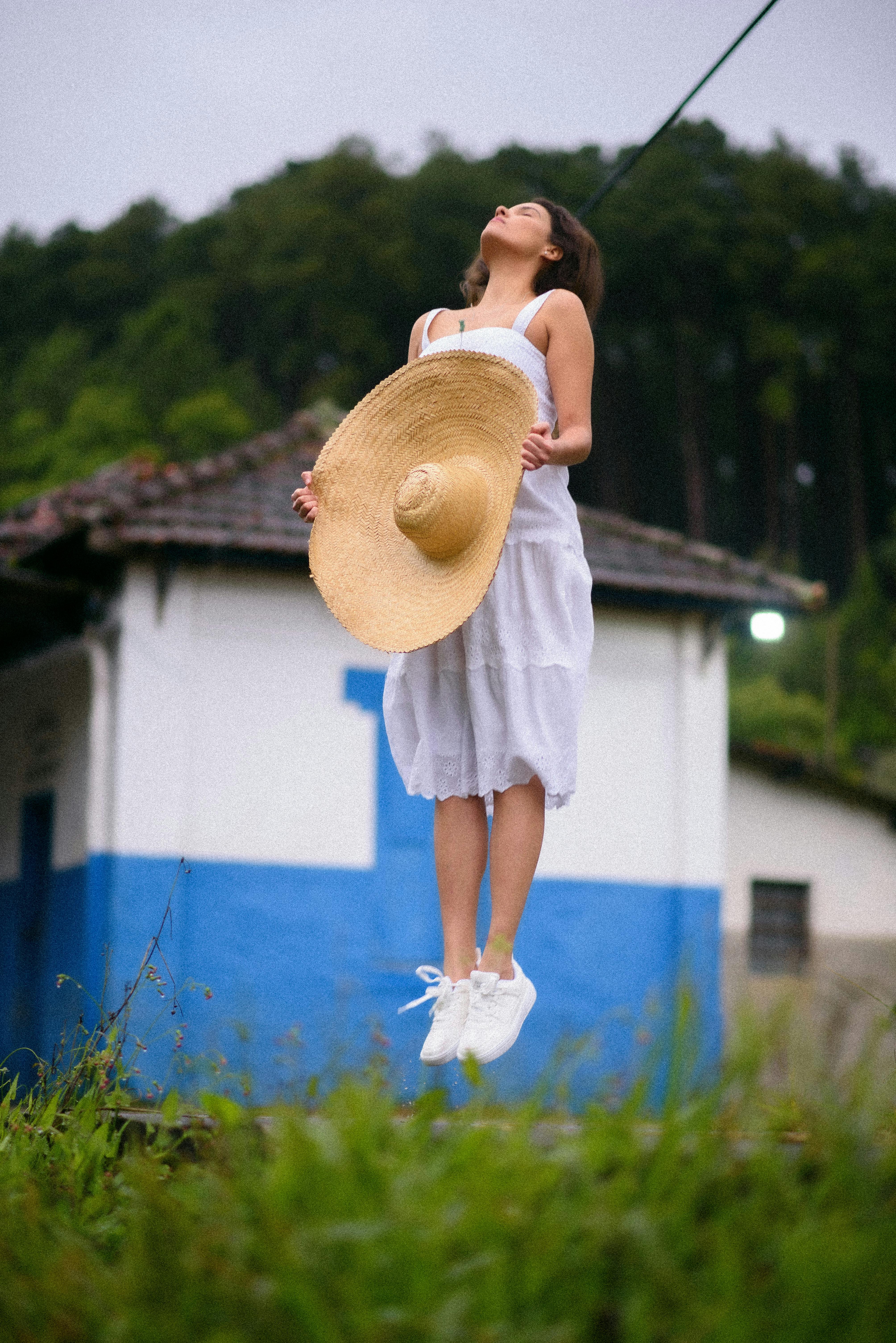 Woman in Dress with Hat in Jump · Free Stock Photo