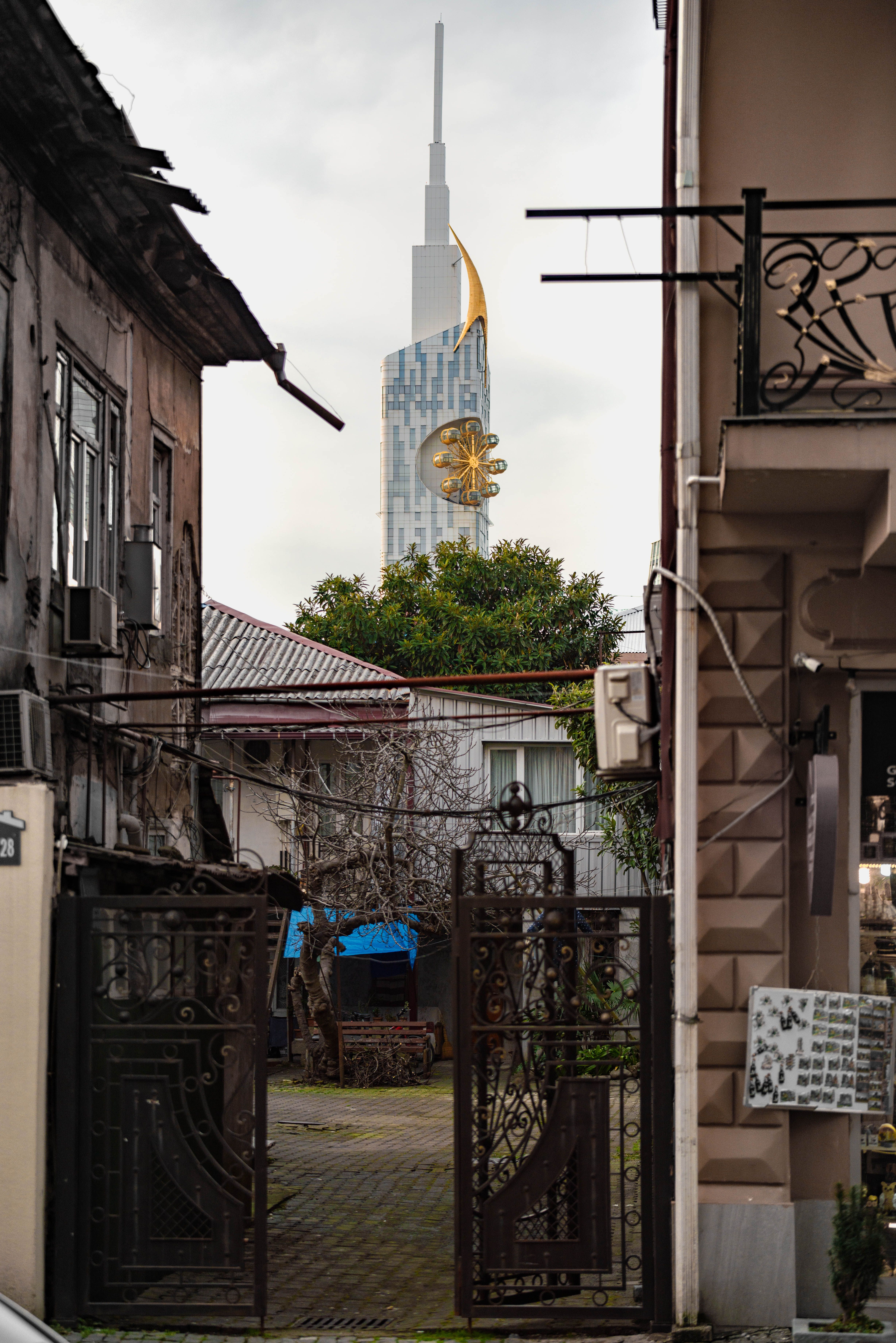 Church Tower Seen between Houses · Free Stock Photo
