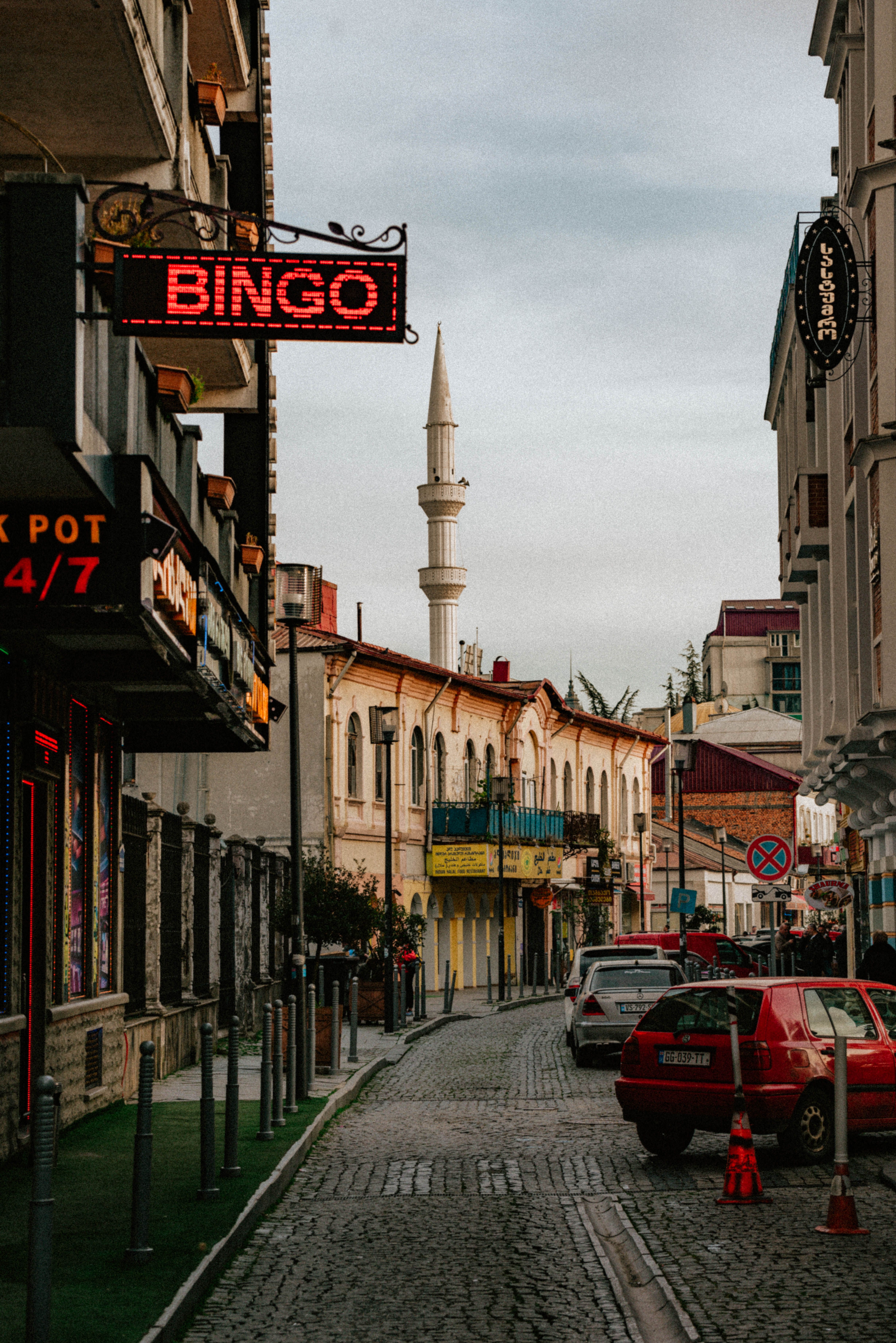 Minaret Visible above Lovely City Street · Free Stock Photo