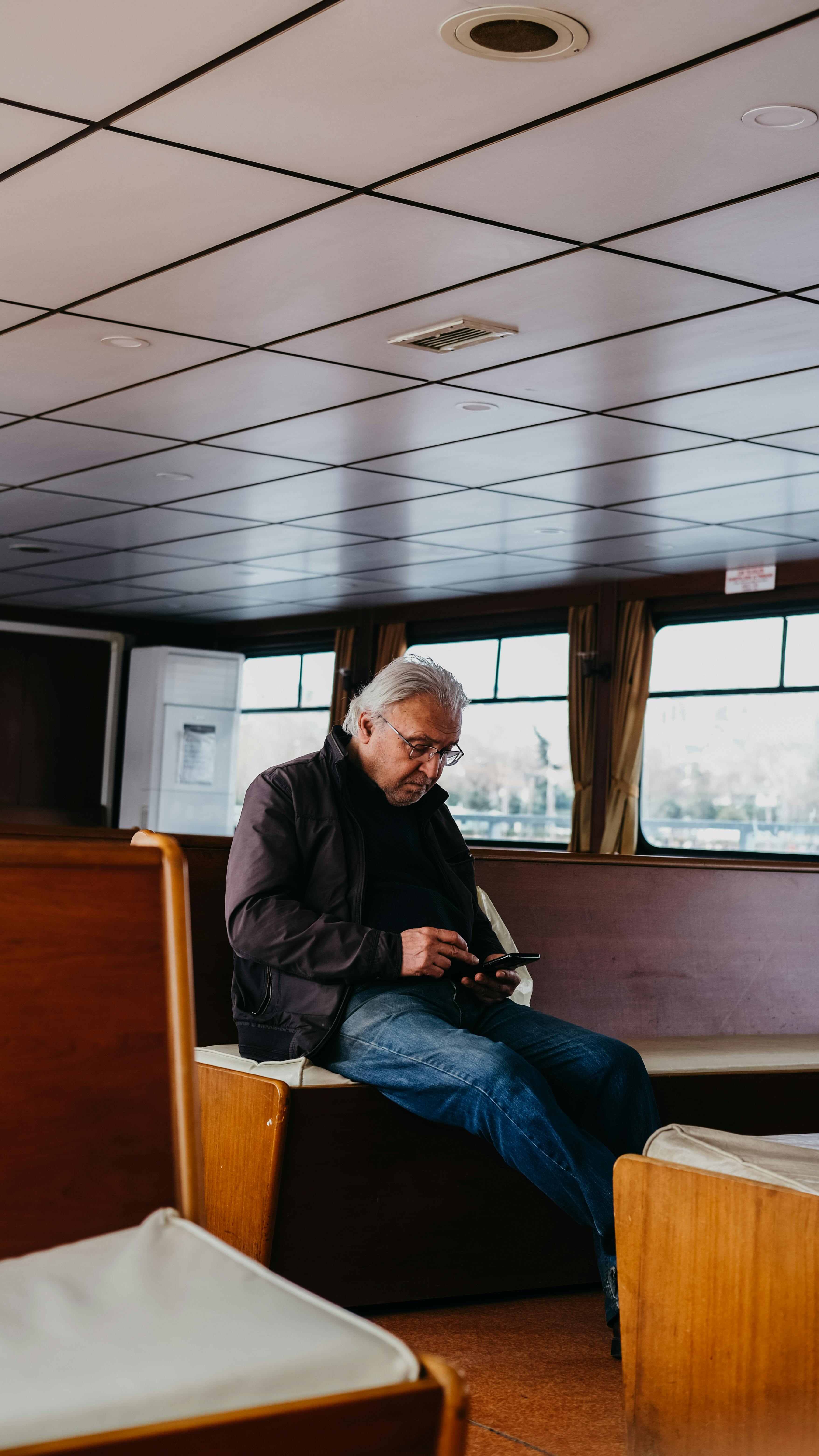 An Elderly Man Sitting on a Train · Free Stock Photo