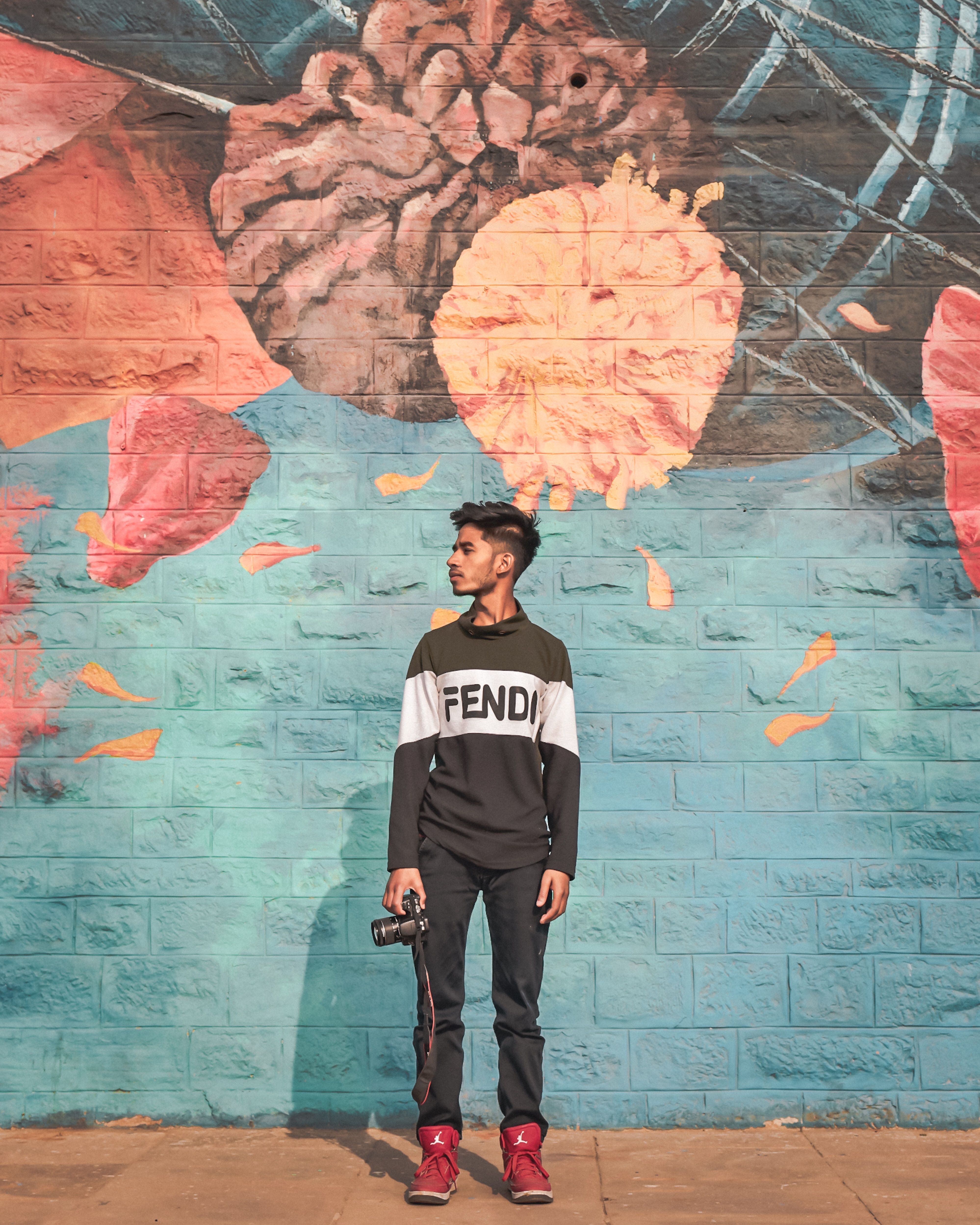 Man Posing by Mural on Wall · Free Stock Photo