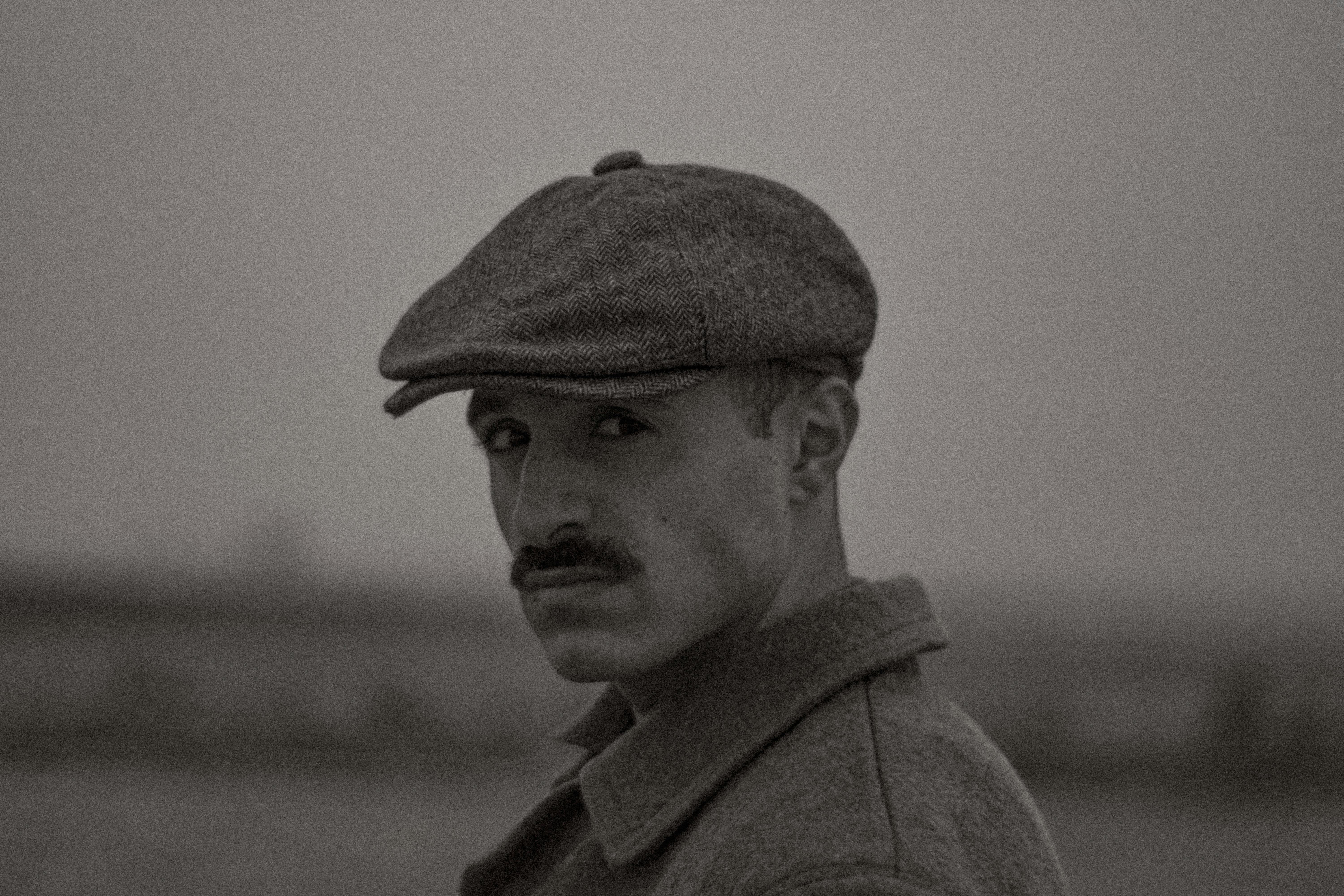 A Man in a Cap in Black and White · Free Stock Photo