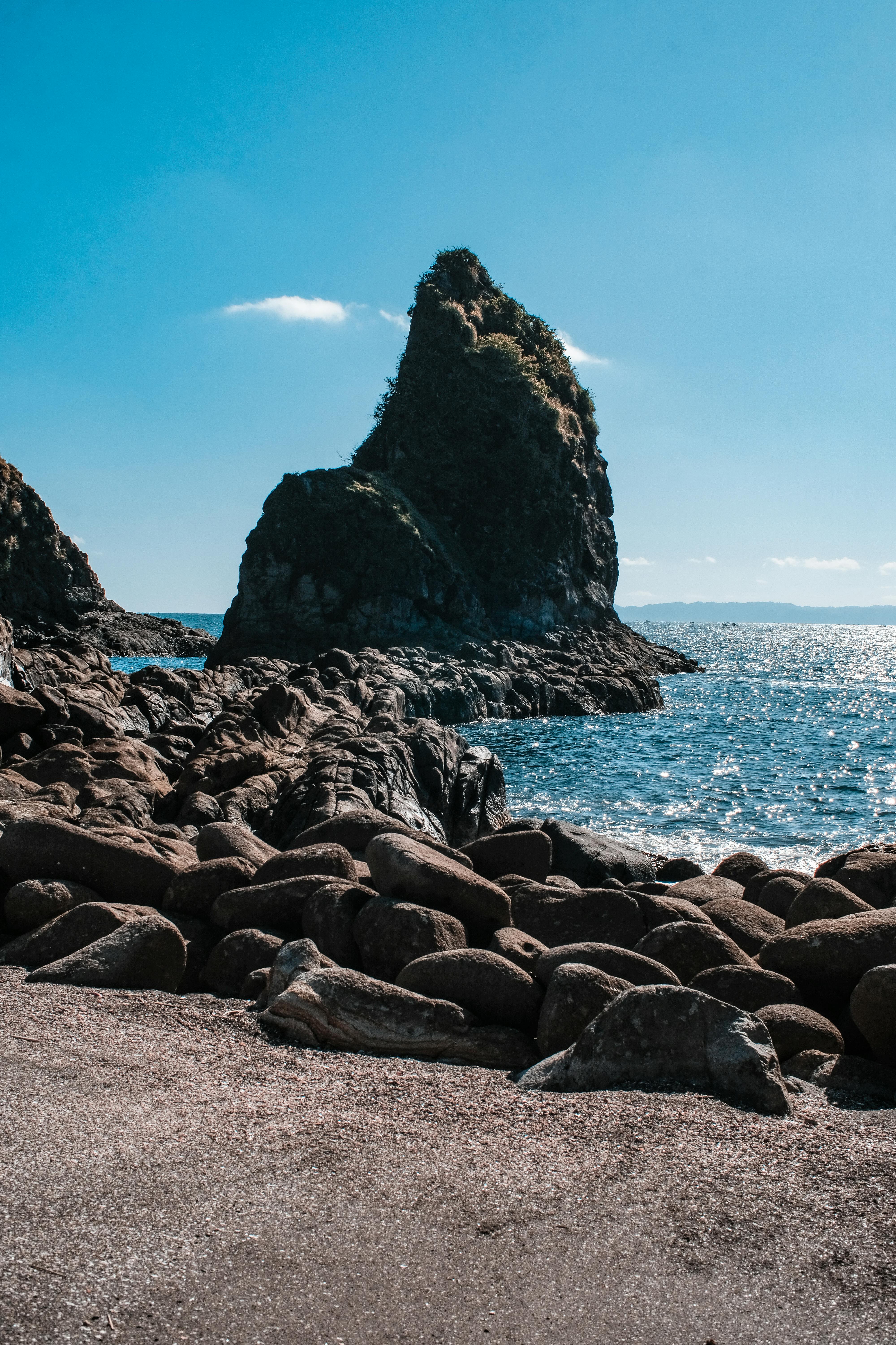 People Walking on Rock at Sea · Free Stock Photo