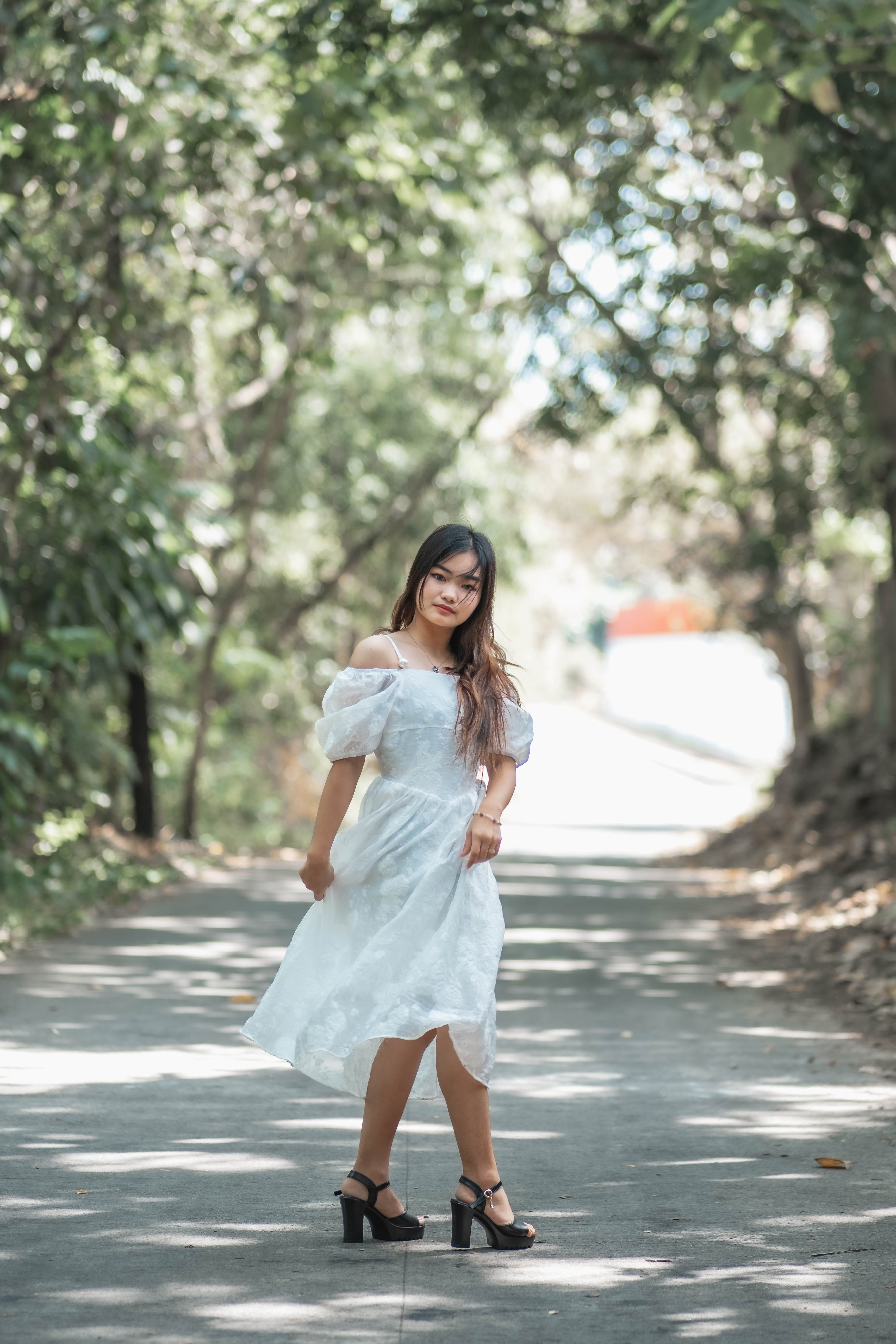 Woman Standing on Side Road · Free Stock Photo