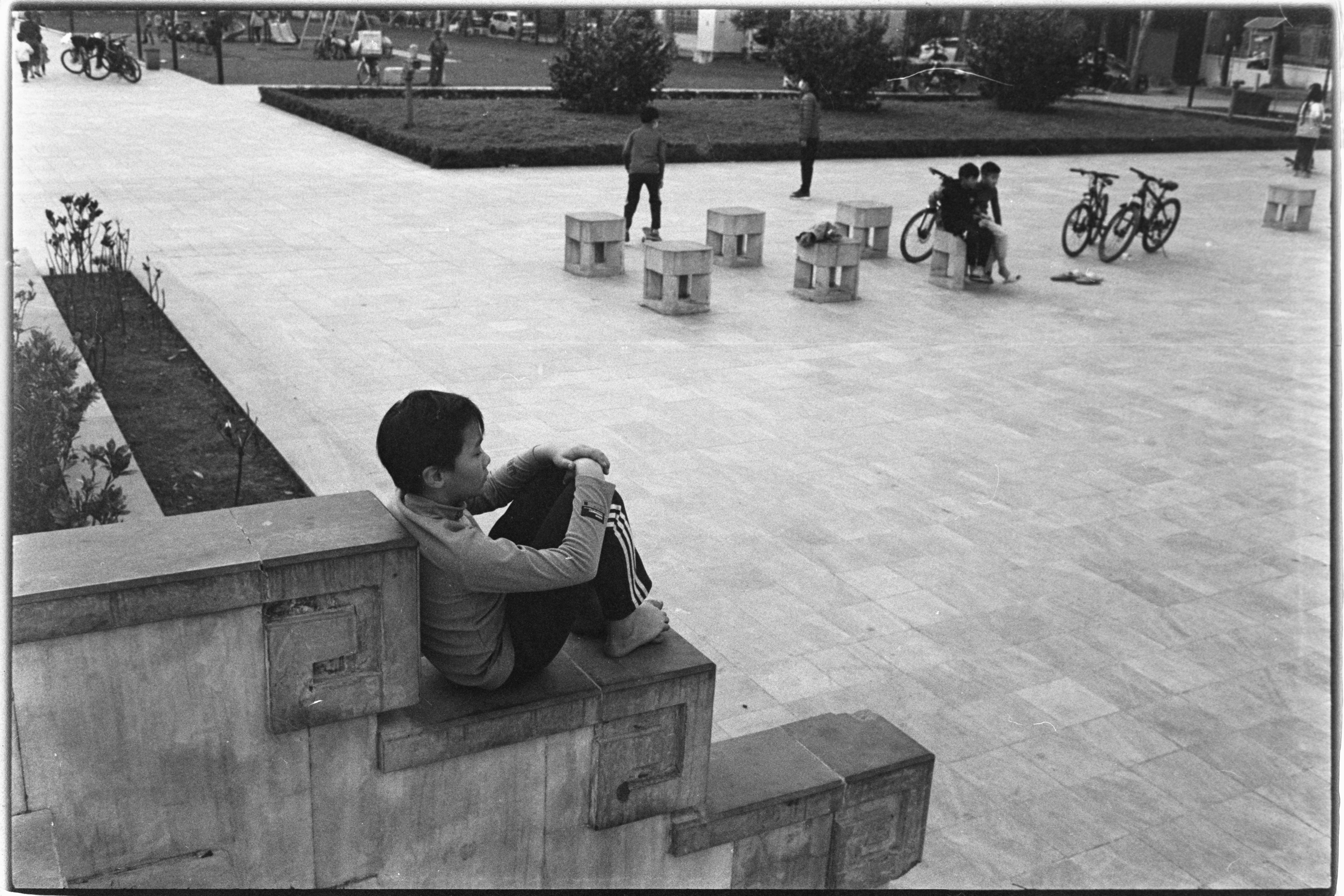 Boy Sitting on Urban Steps · Free Stock Photo