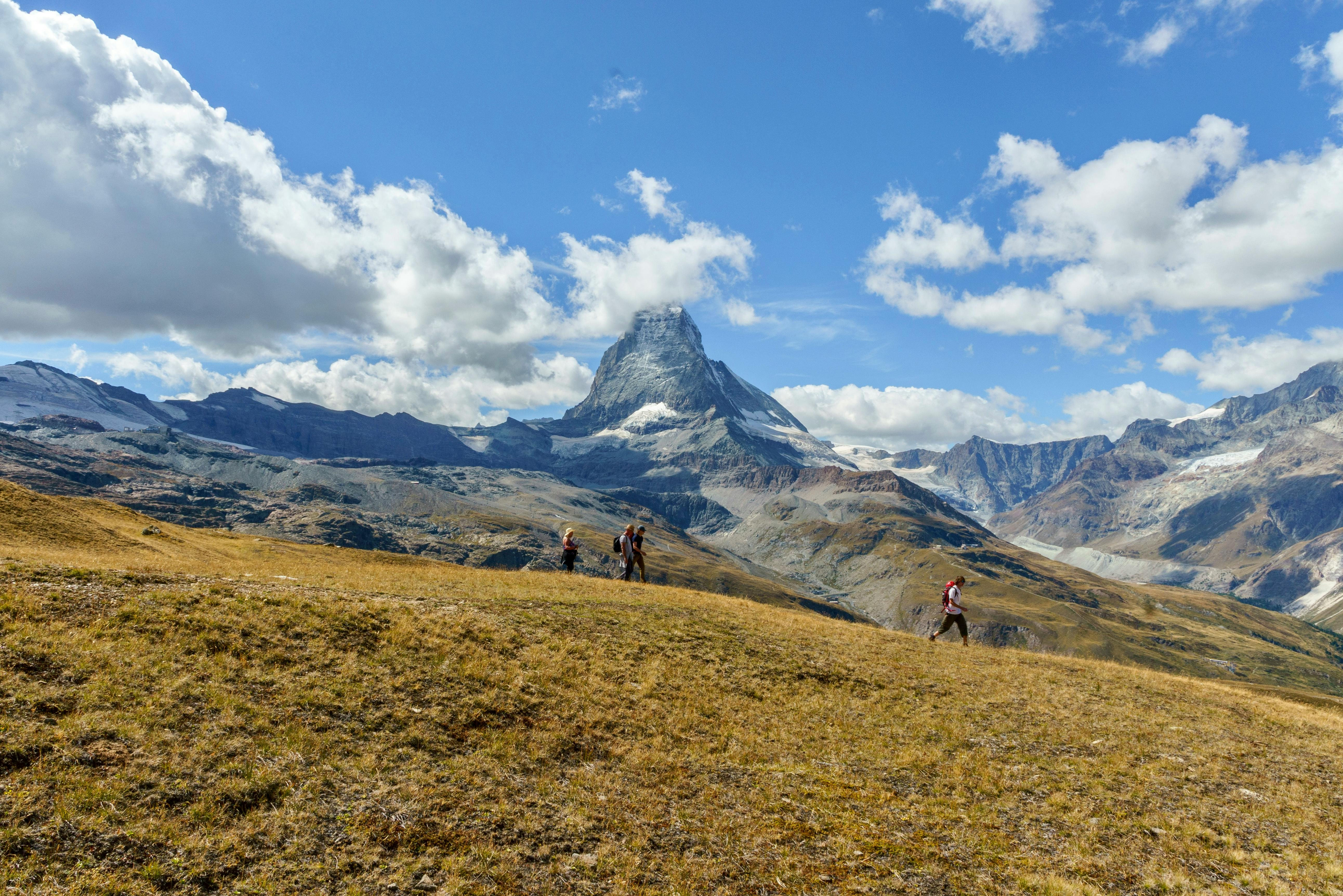 Photo of Person Standing Across the Mountain · Free Stock Photo