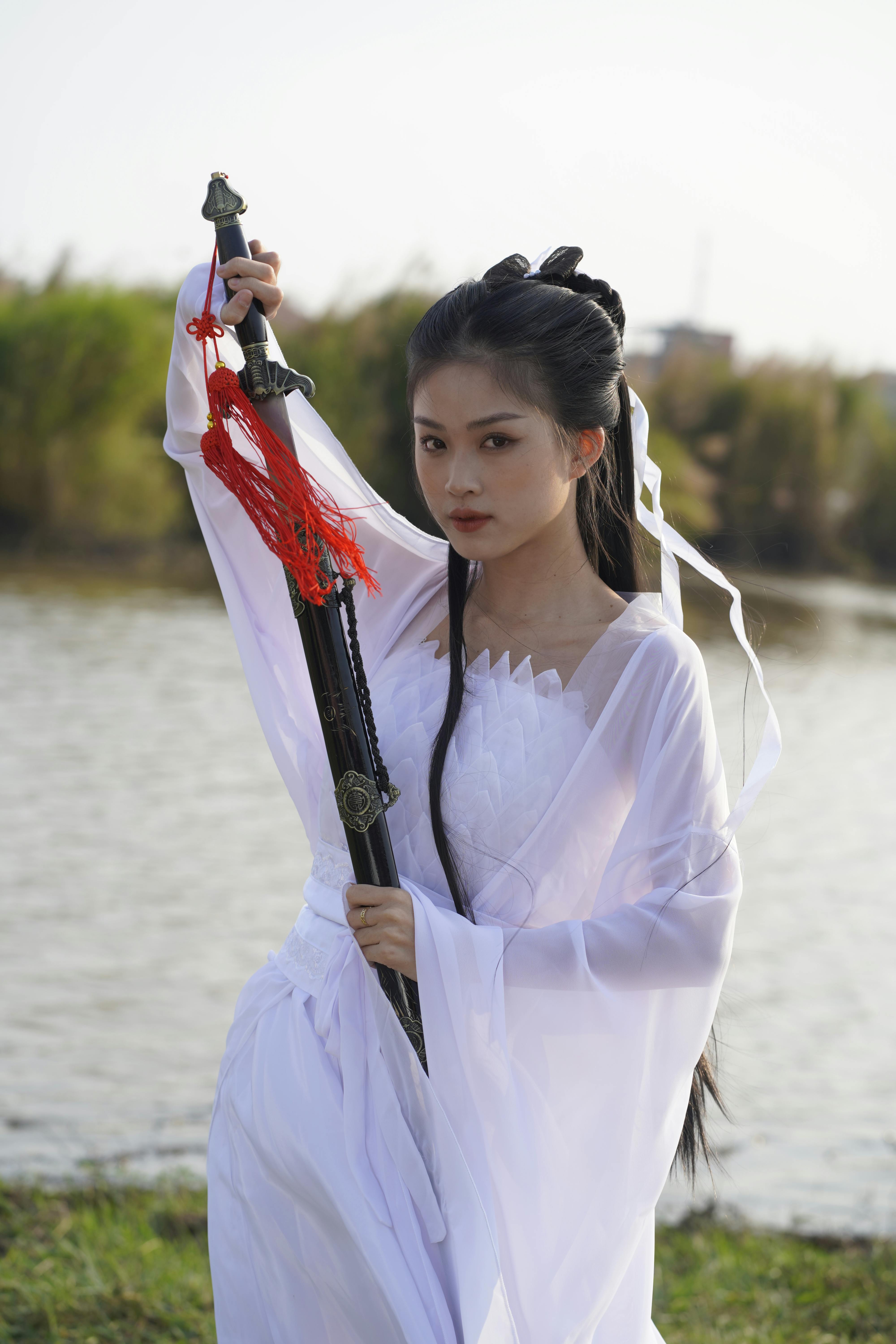 Woman Sitting on Slide with Sword in Rain · Free Stock Photo