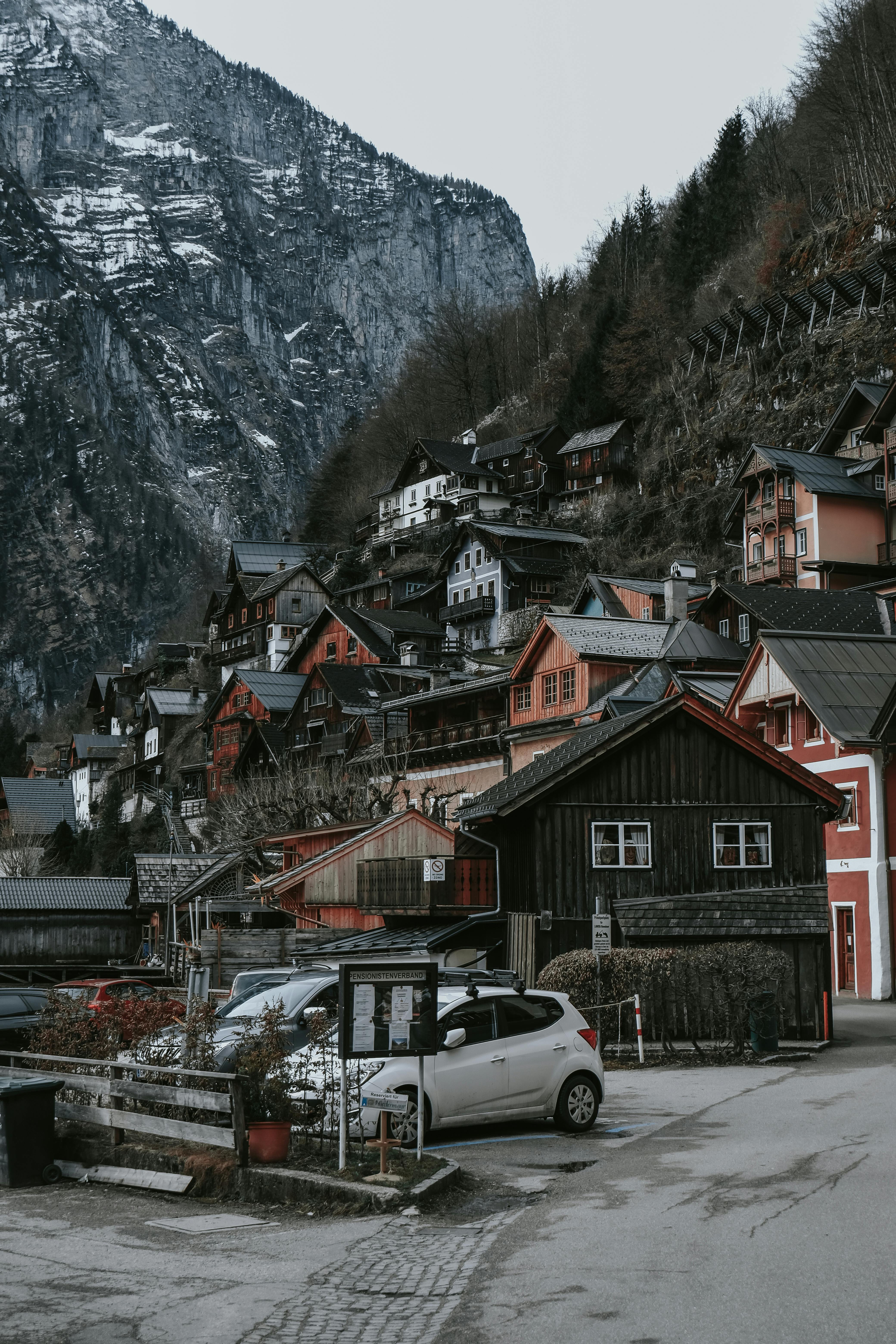 A mountain village with houses and cars parked in front of it · Free ...