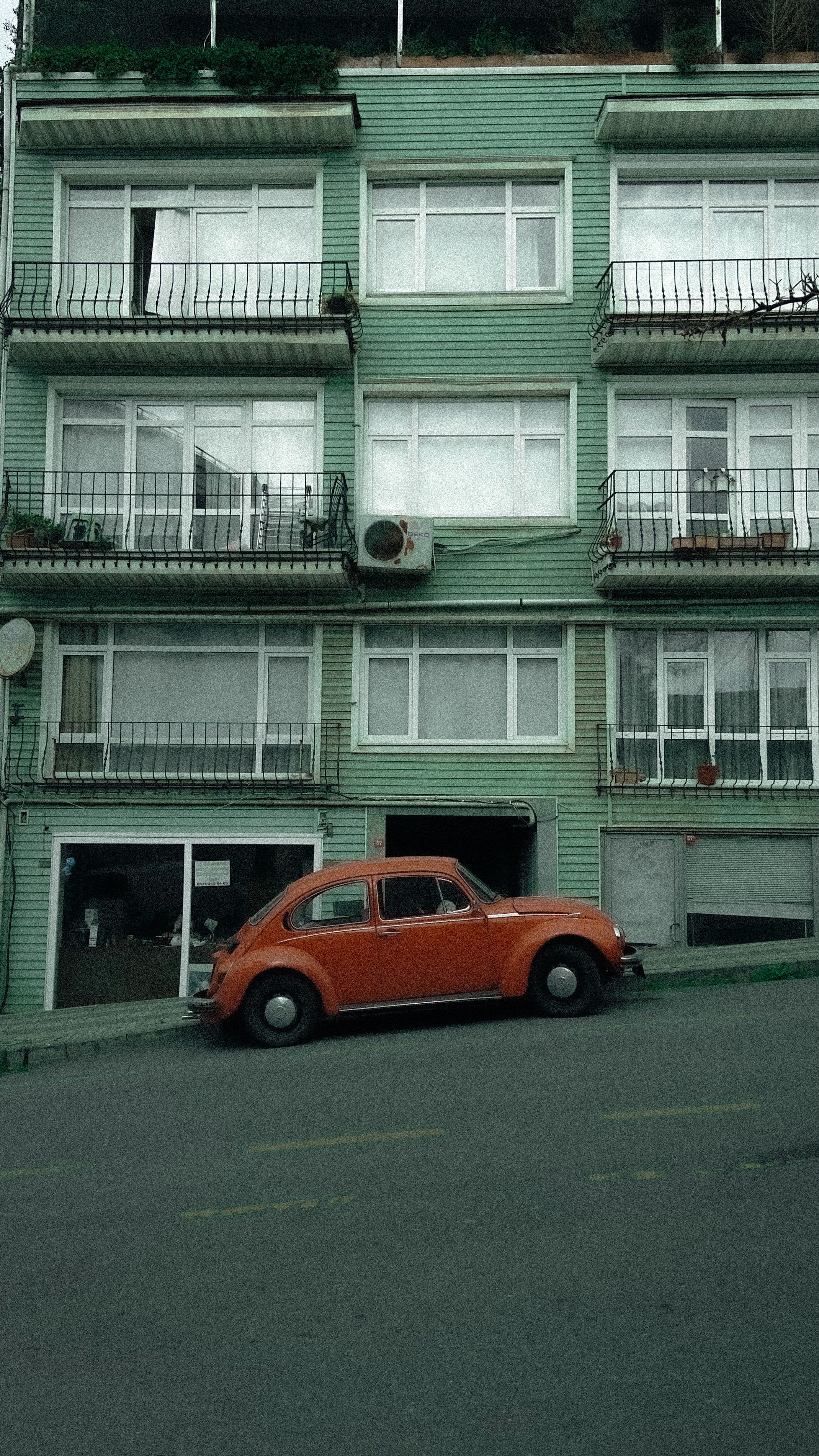 Vintage Volkswagen Beetle Parked on Steep Street · Free Stock Photo