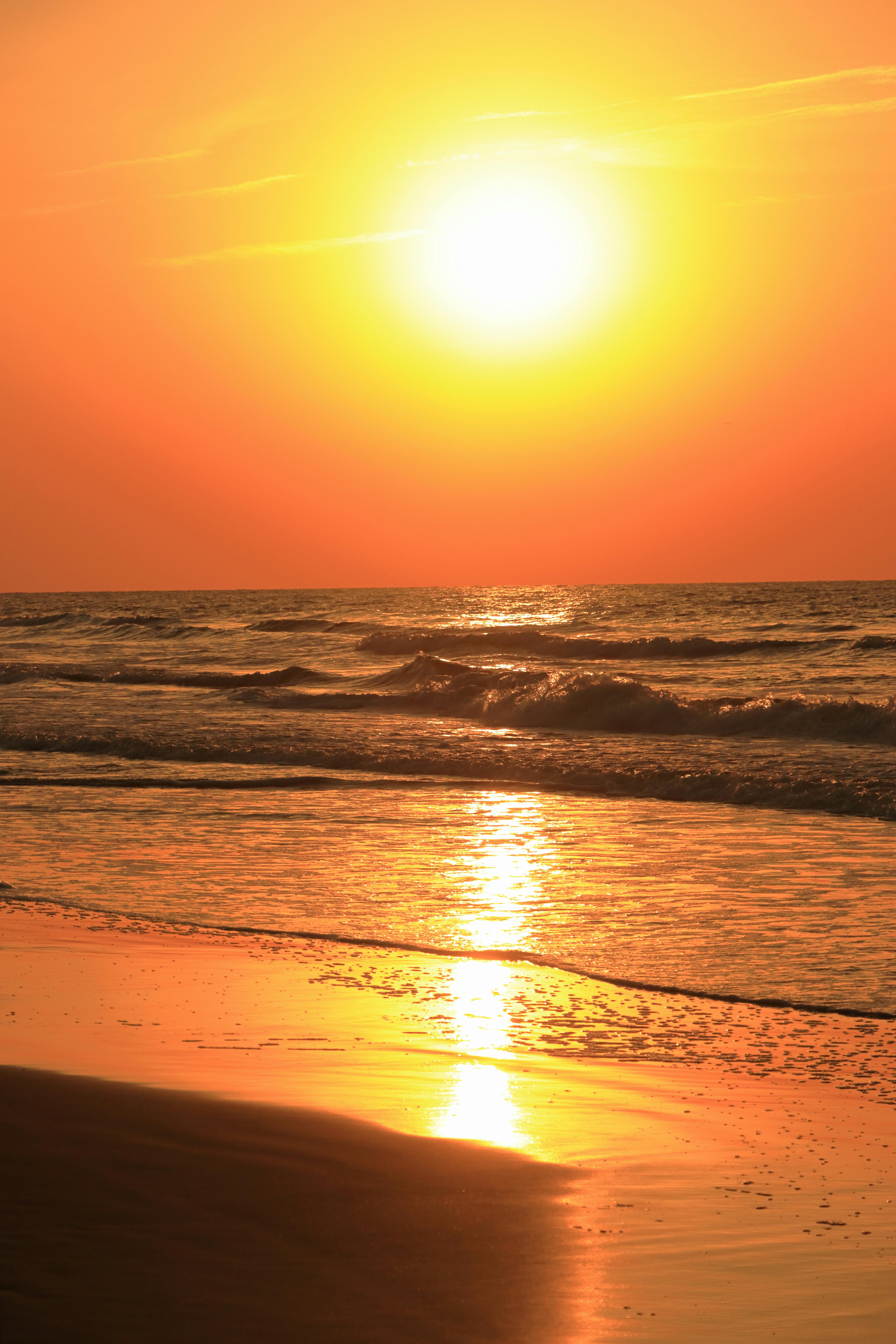 Rough seascape and Sun in Orange Sky · Free Stock Photo