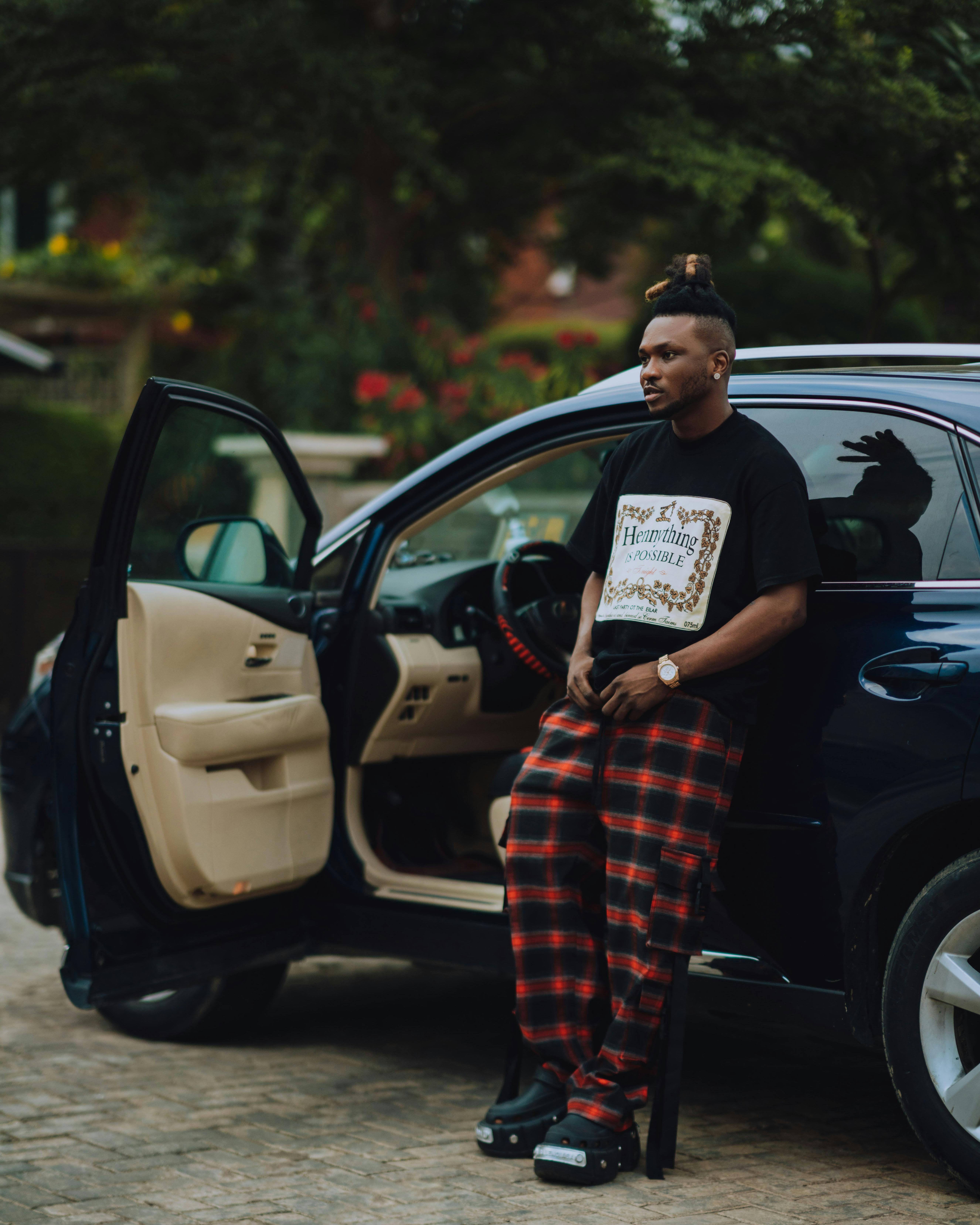 Man with Dreadlocks Leaning Against Car · Free Stock Photo