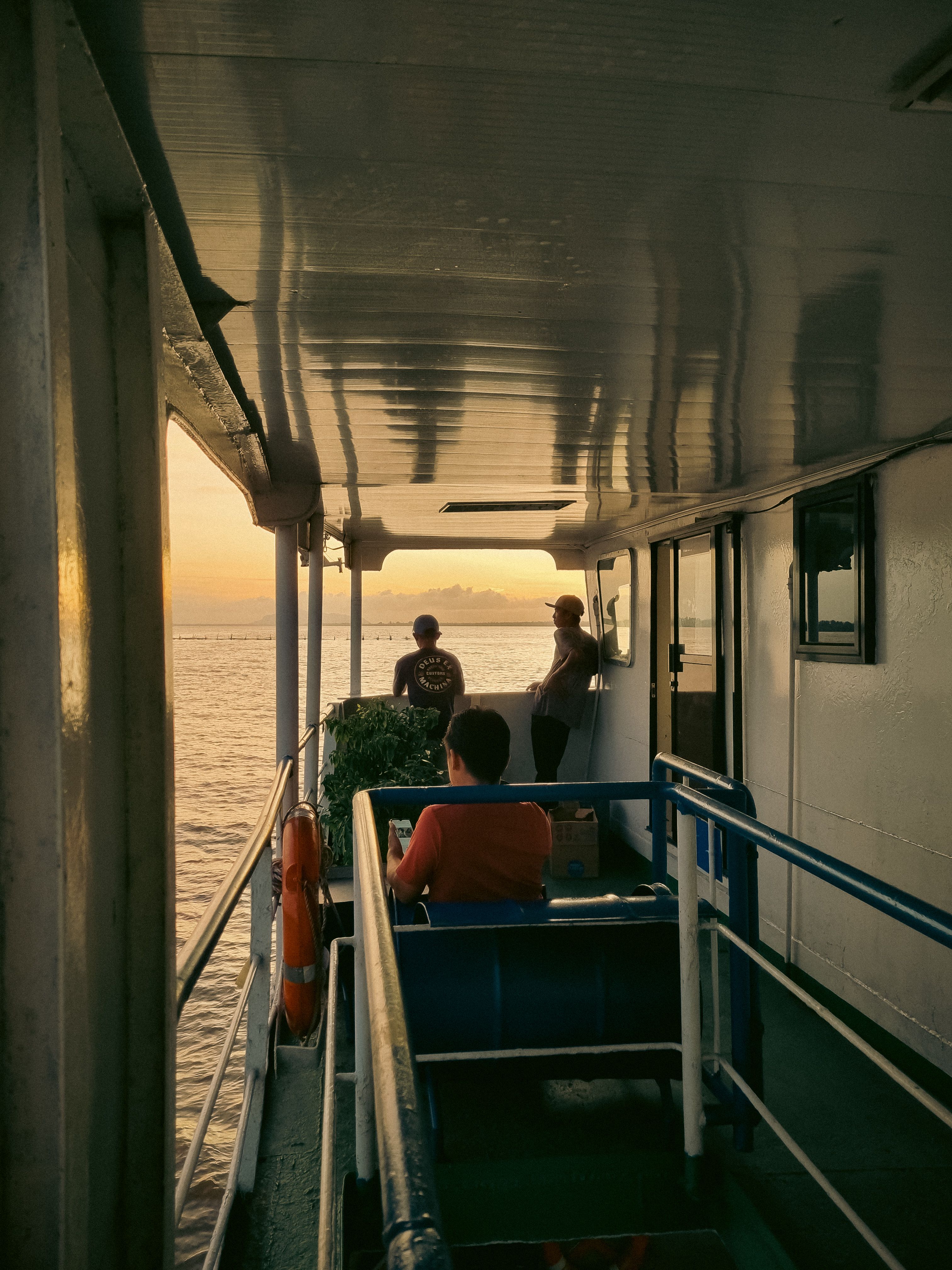 Man Sitting on Ship Deck · Free Stock Photo