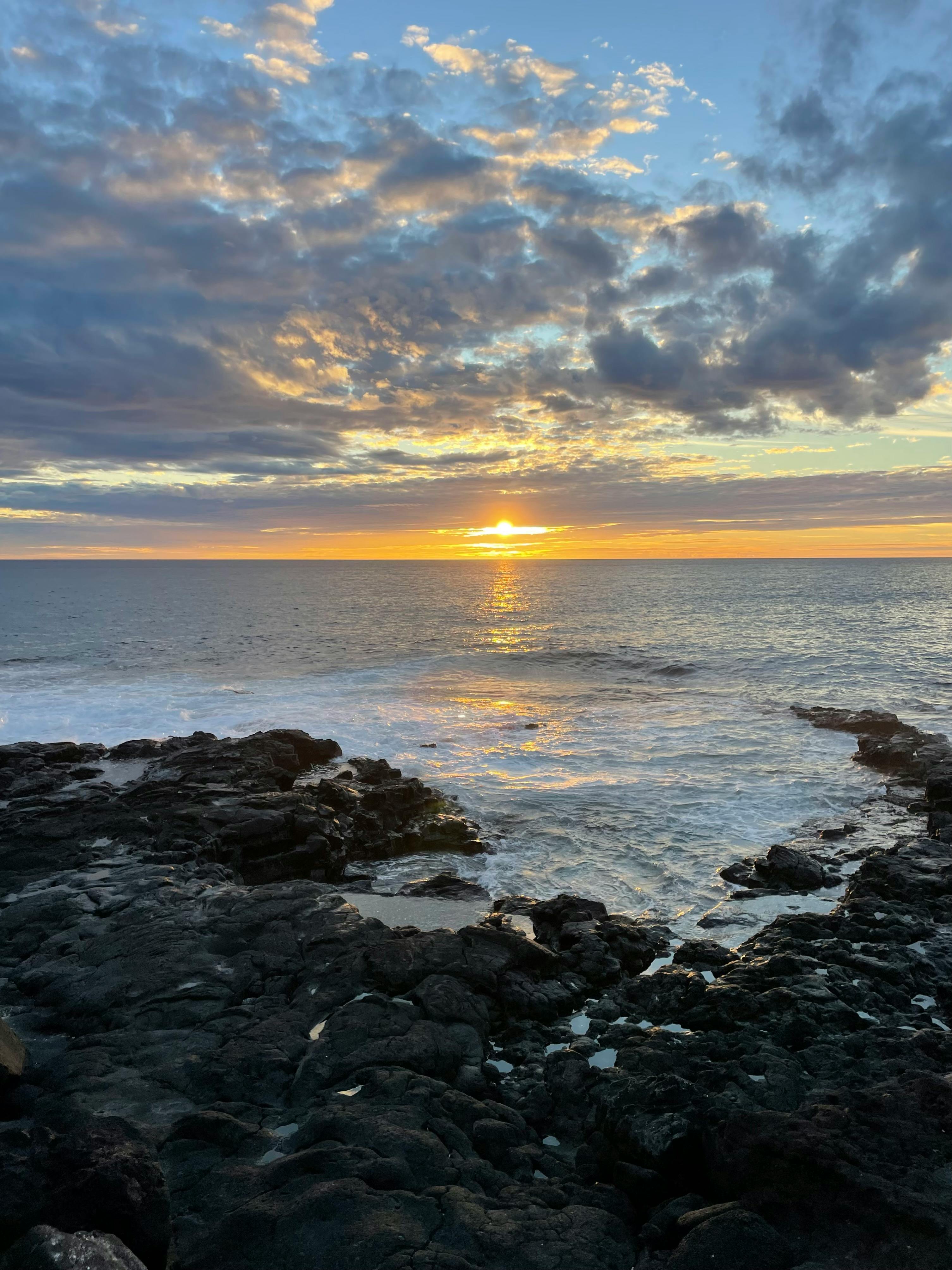 Silhouette of a Woman Standing on the Beach with Her Arms Raised at ...