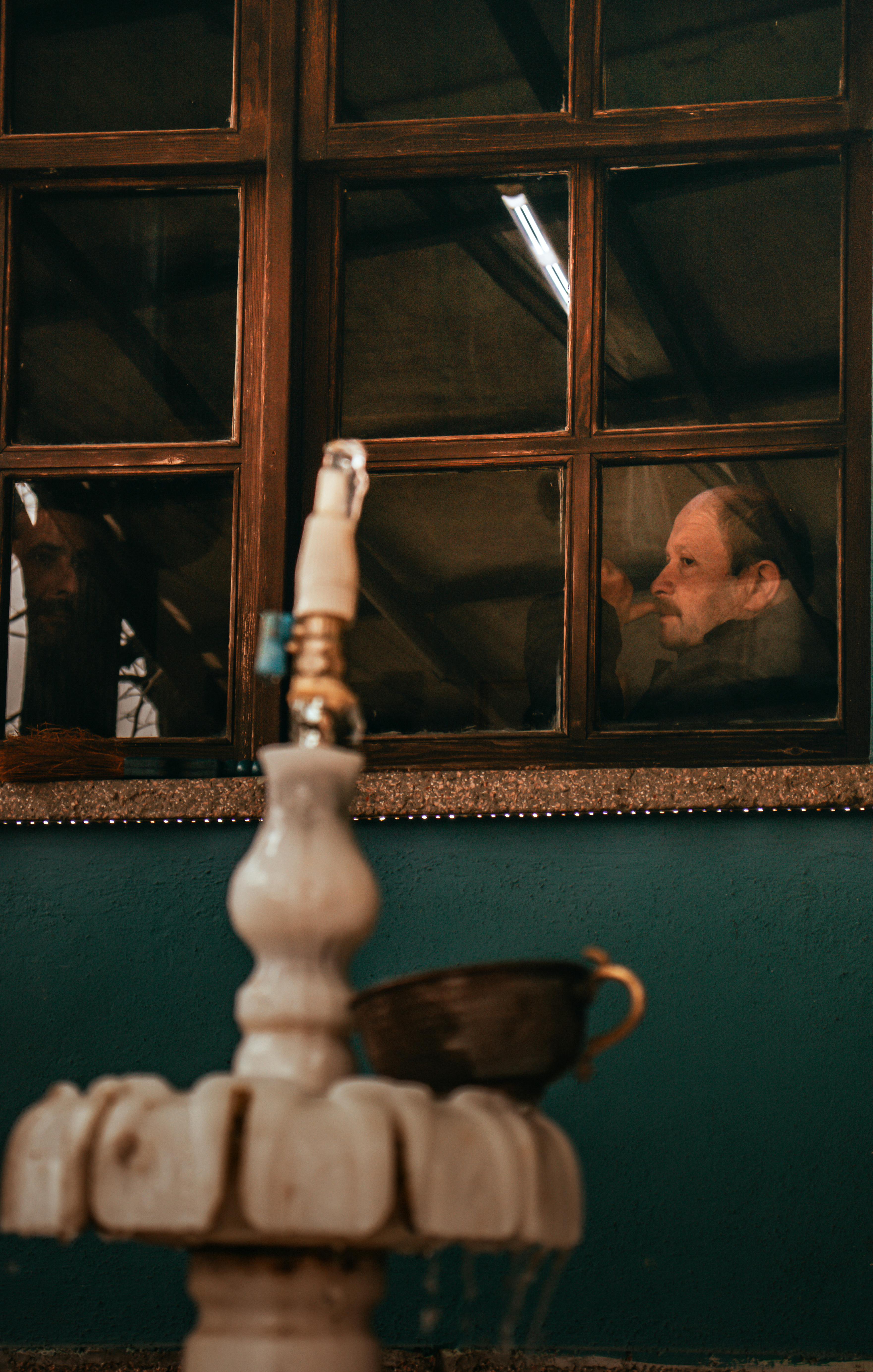 Sitting Man Face behind Windows · Free Stock Photo