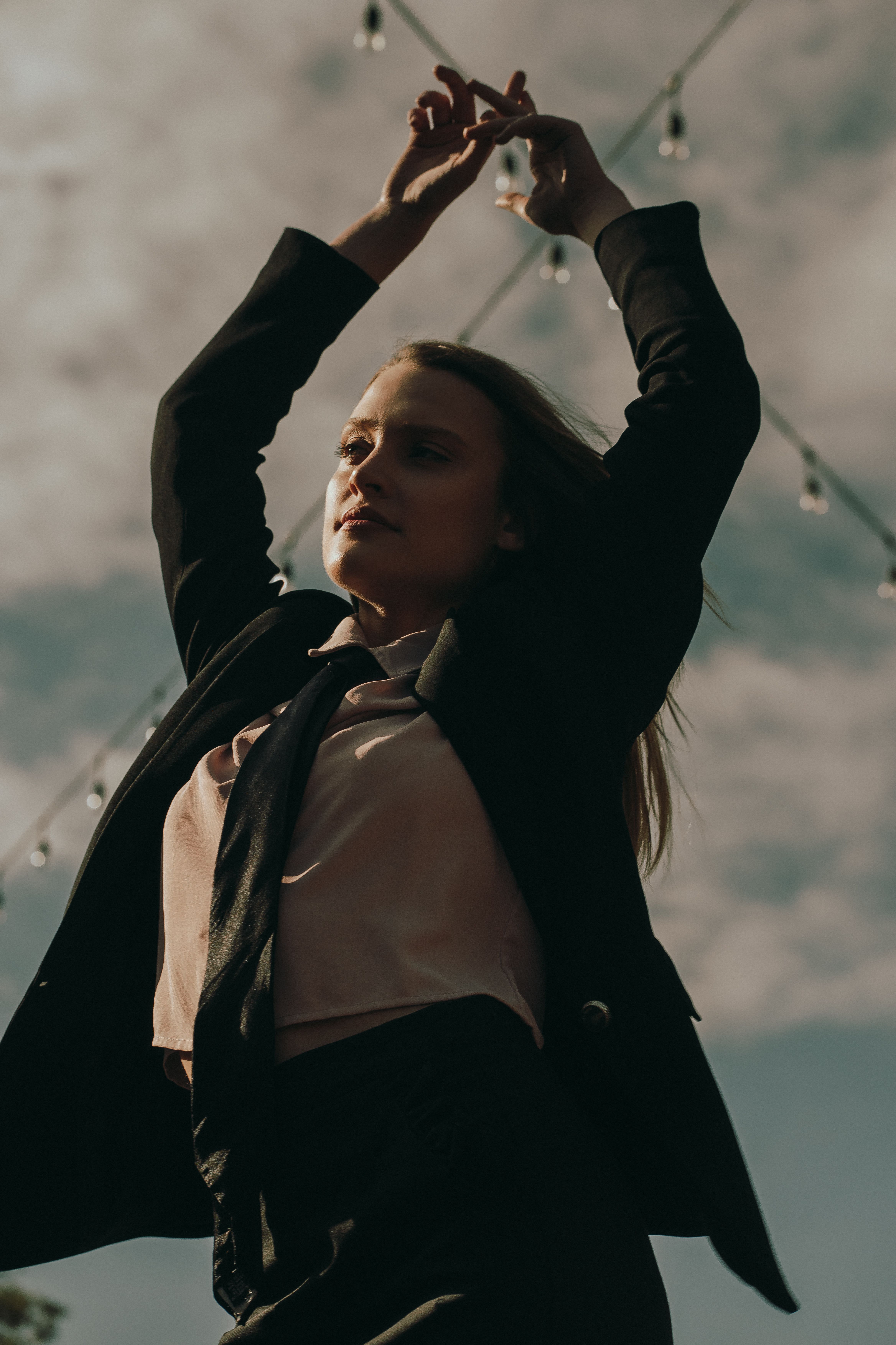 Woman Posing with Arms Raised · Free Stock Photo